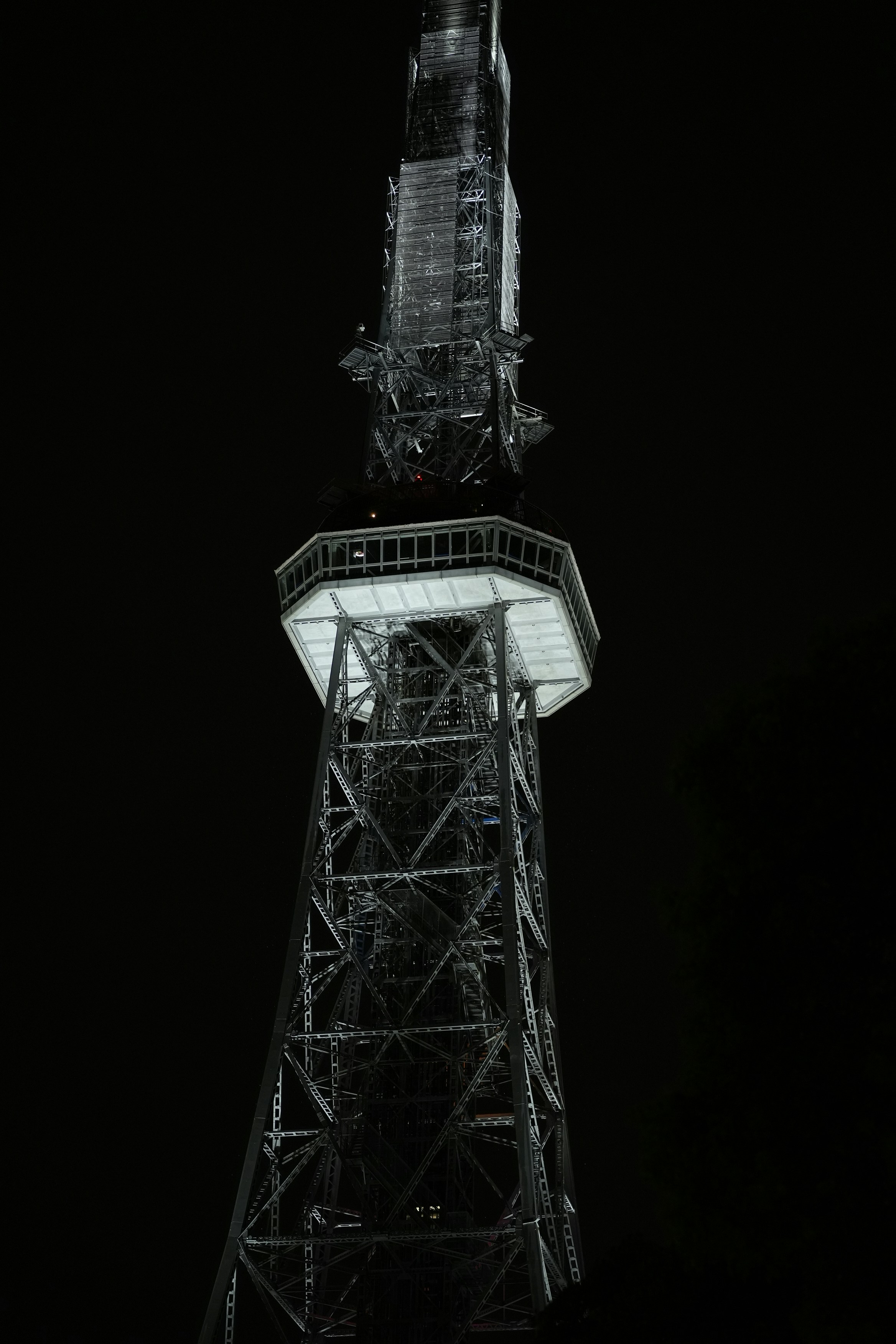Nighttime ascent: the steel lattice of a towering beacon