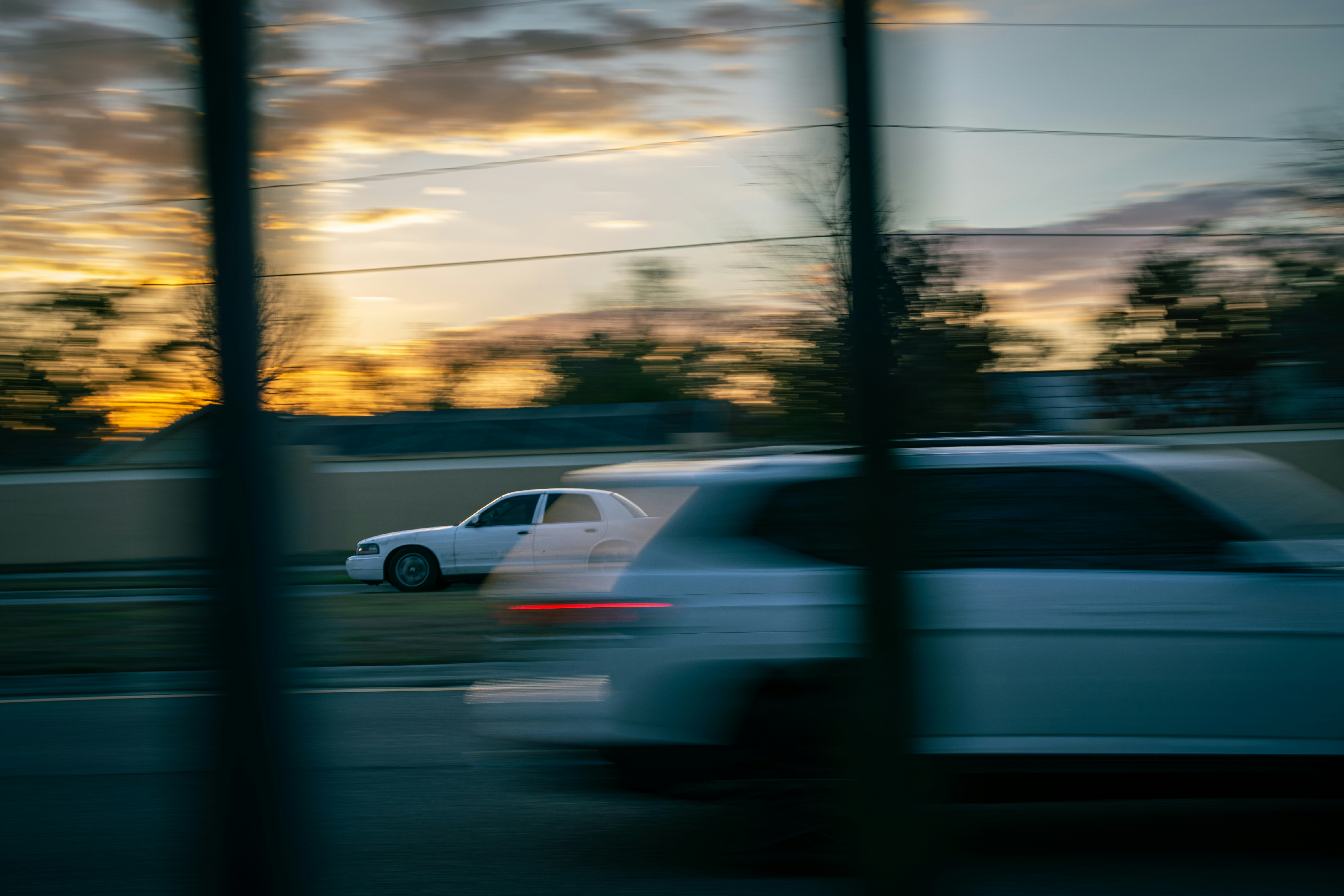 Passing Silence: A Car Window View of Sunset and Blur
