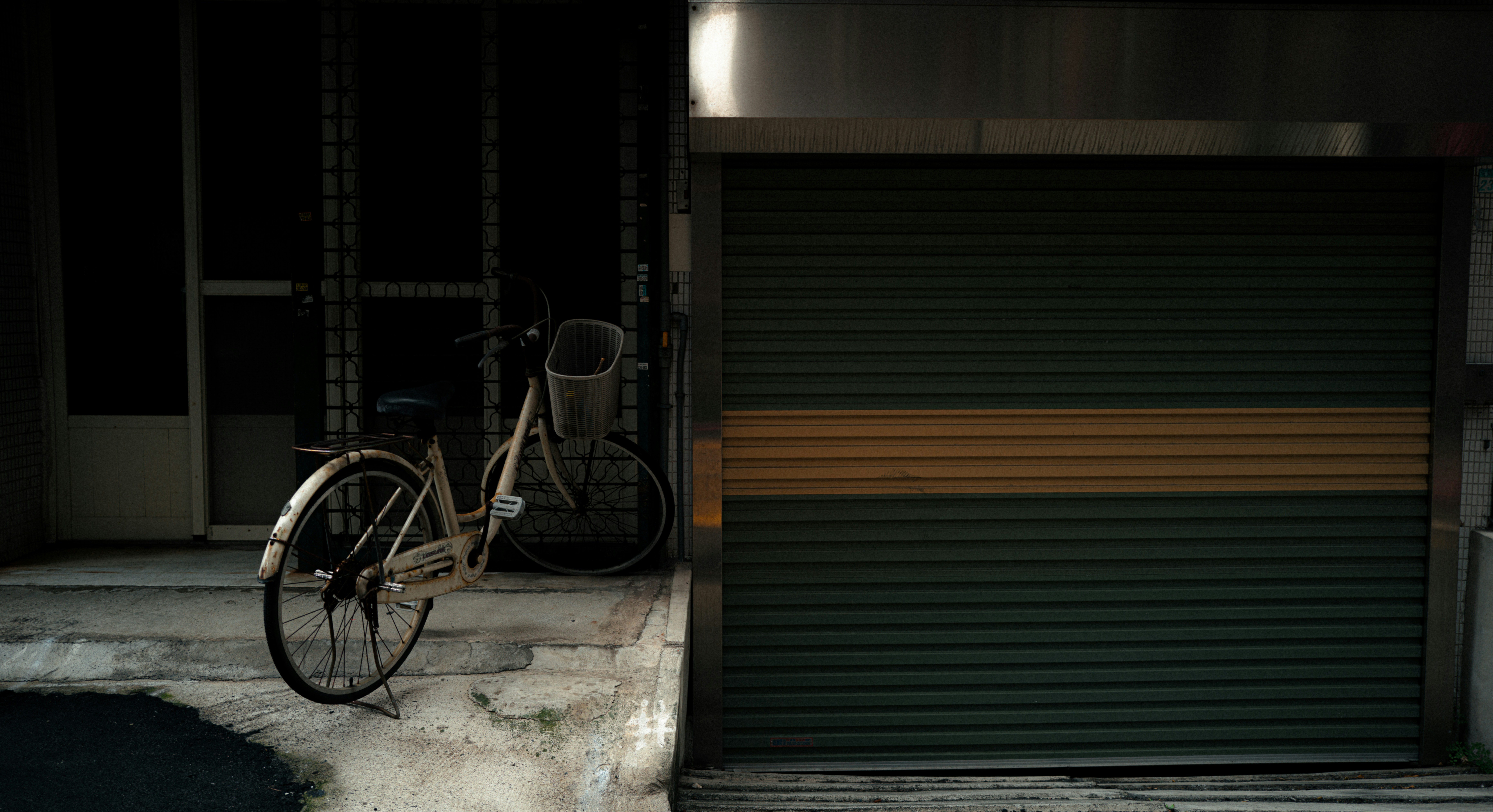 Rust and Quiet: A Bicycle Framed by a Closed Shopfront