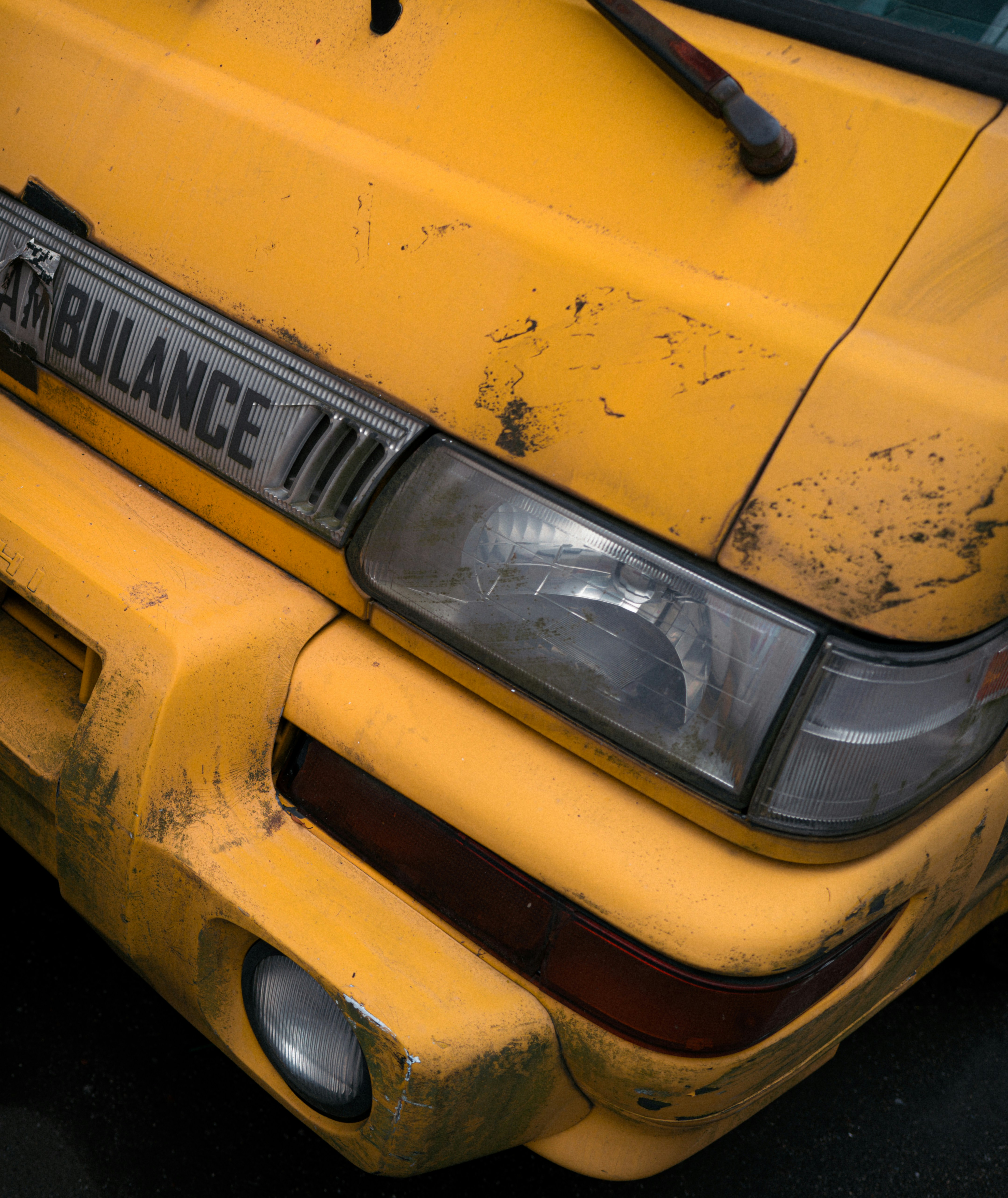Cracked Yellow: A Dented Bus King Face on the Front Grill