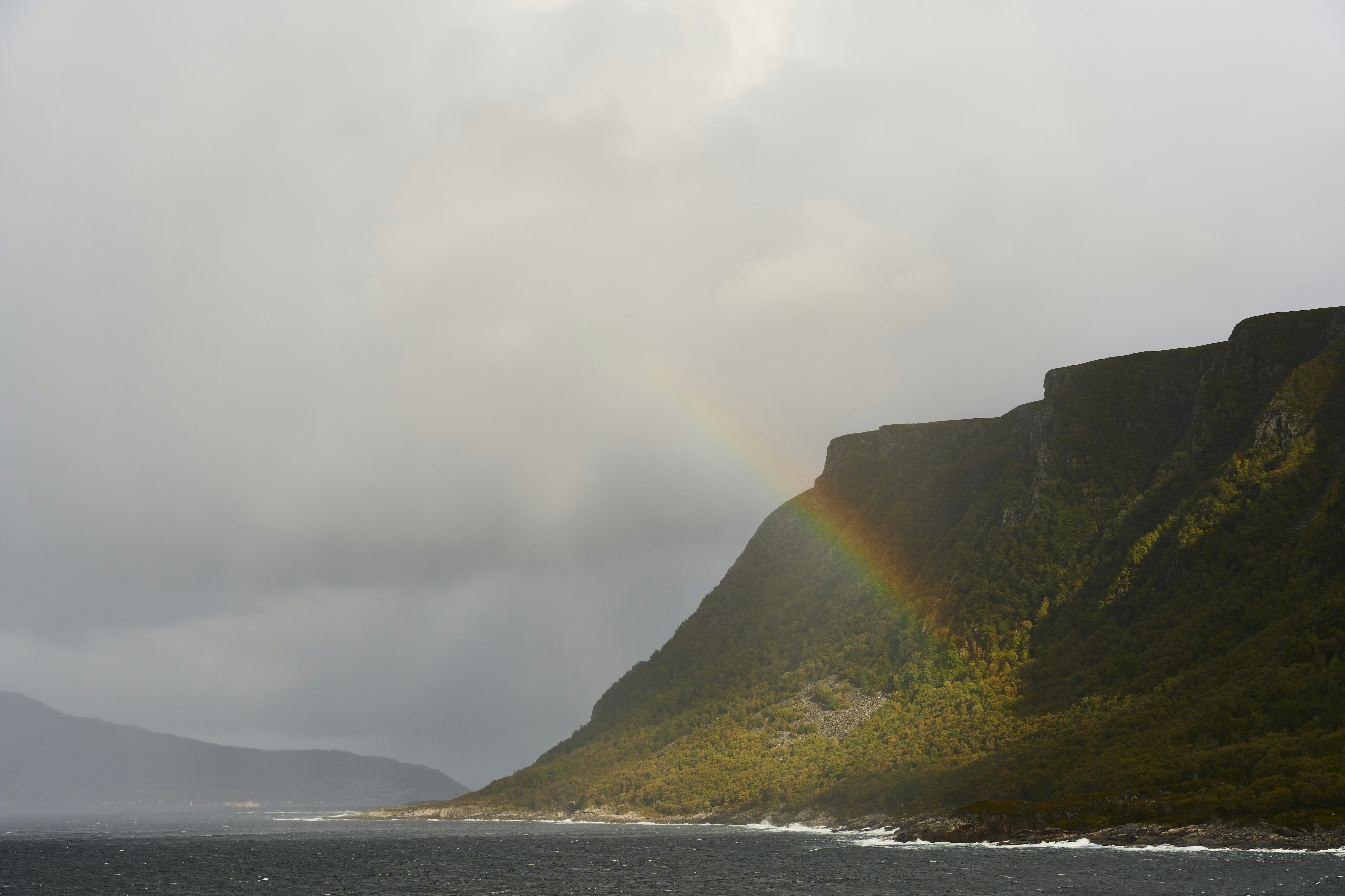 Rainbow over the Coastal Cliffs at Sunset