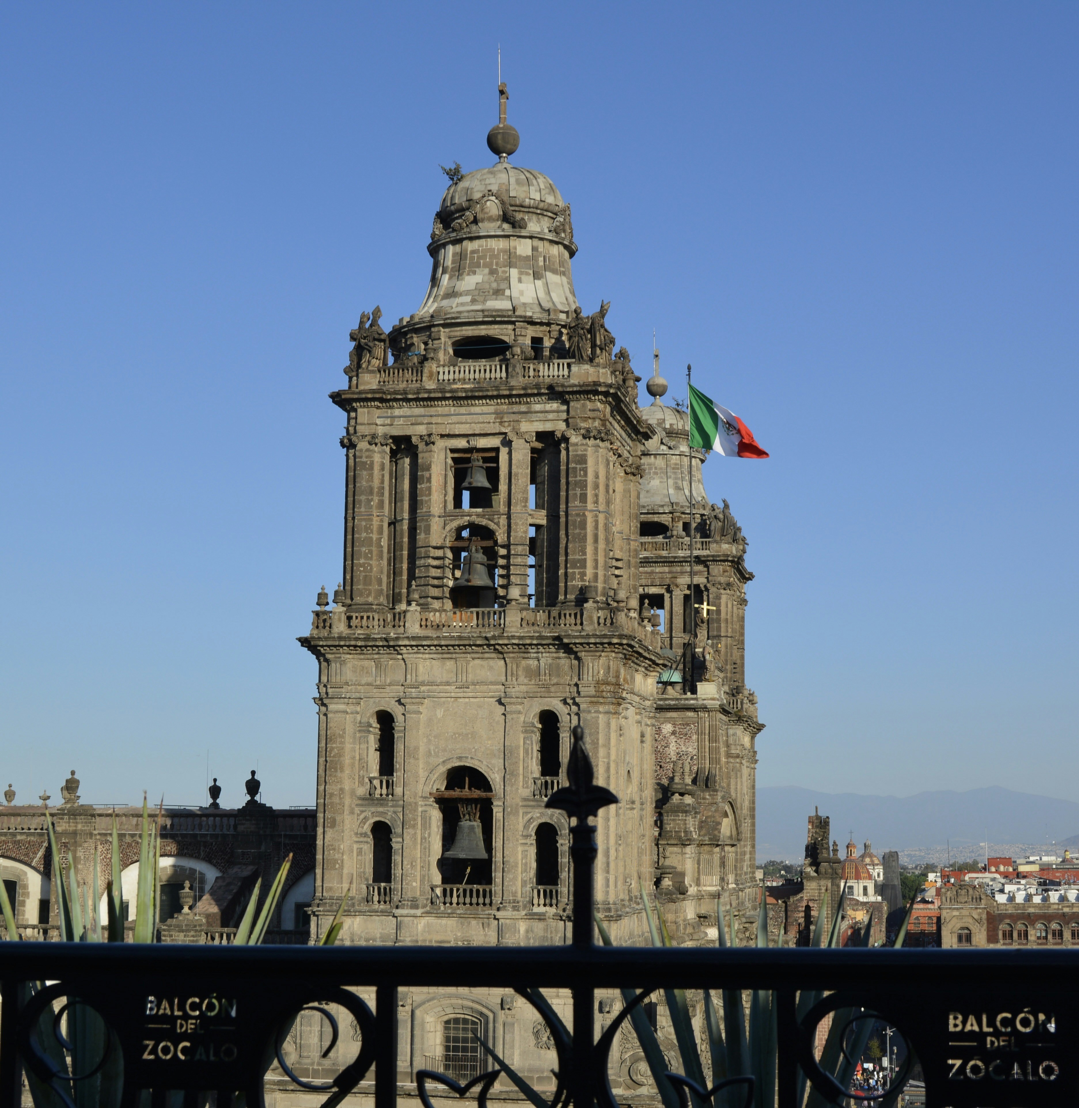 Flag atop the stone Bell Tower: a sunlit Azulejo of history
