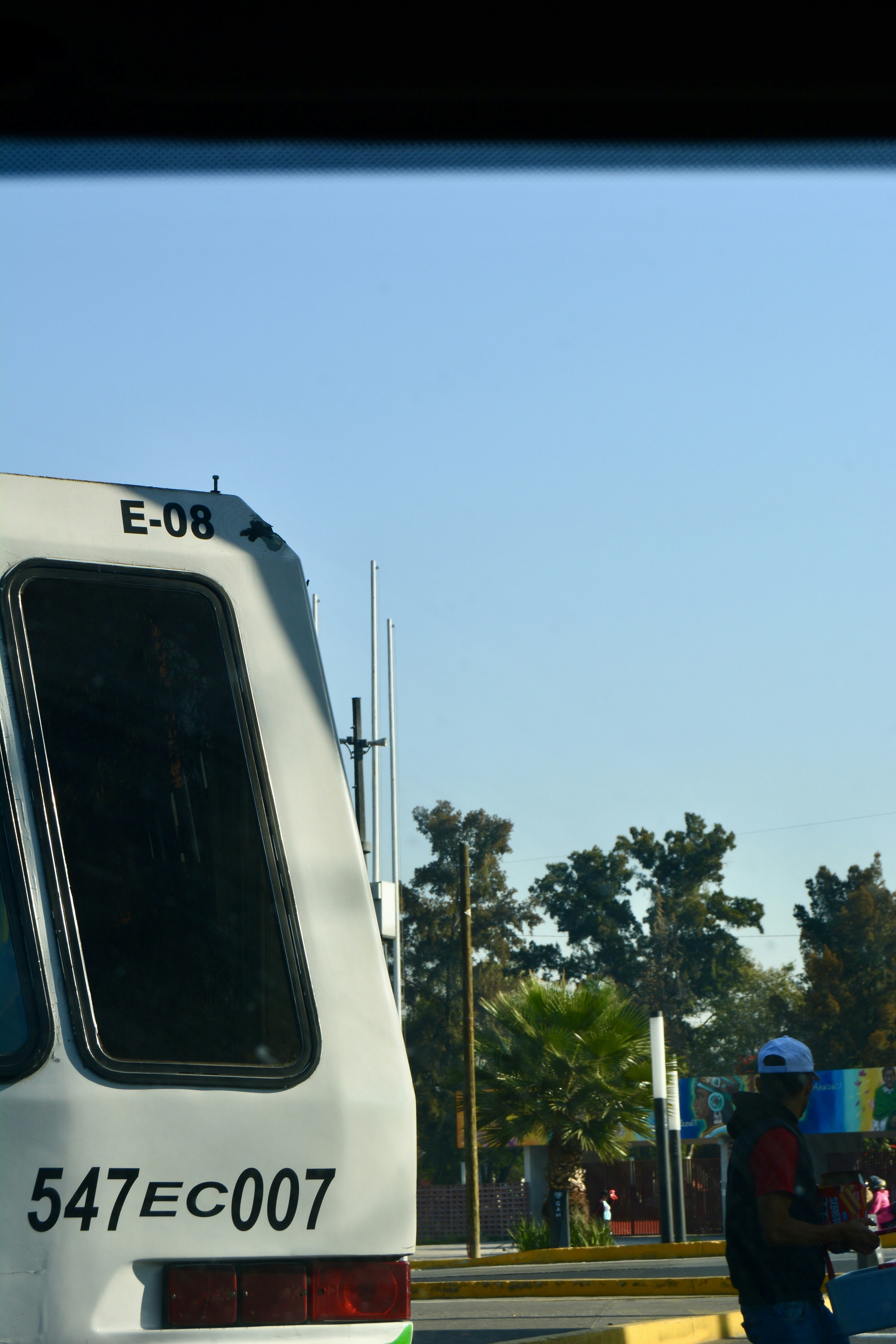 Train Car Window Framing a Sunny Station Scene
