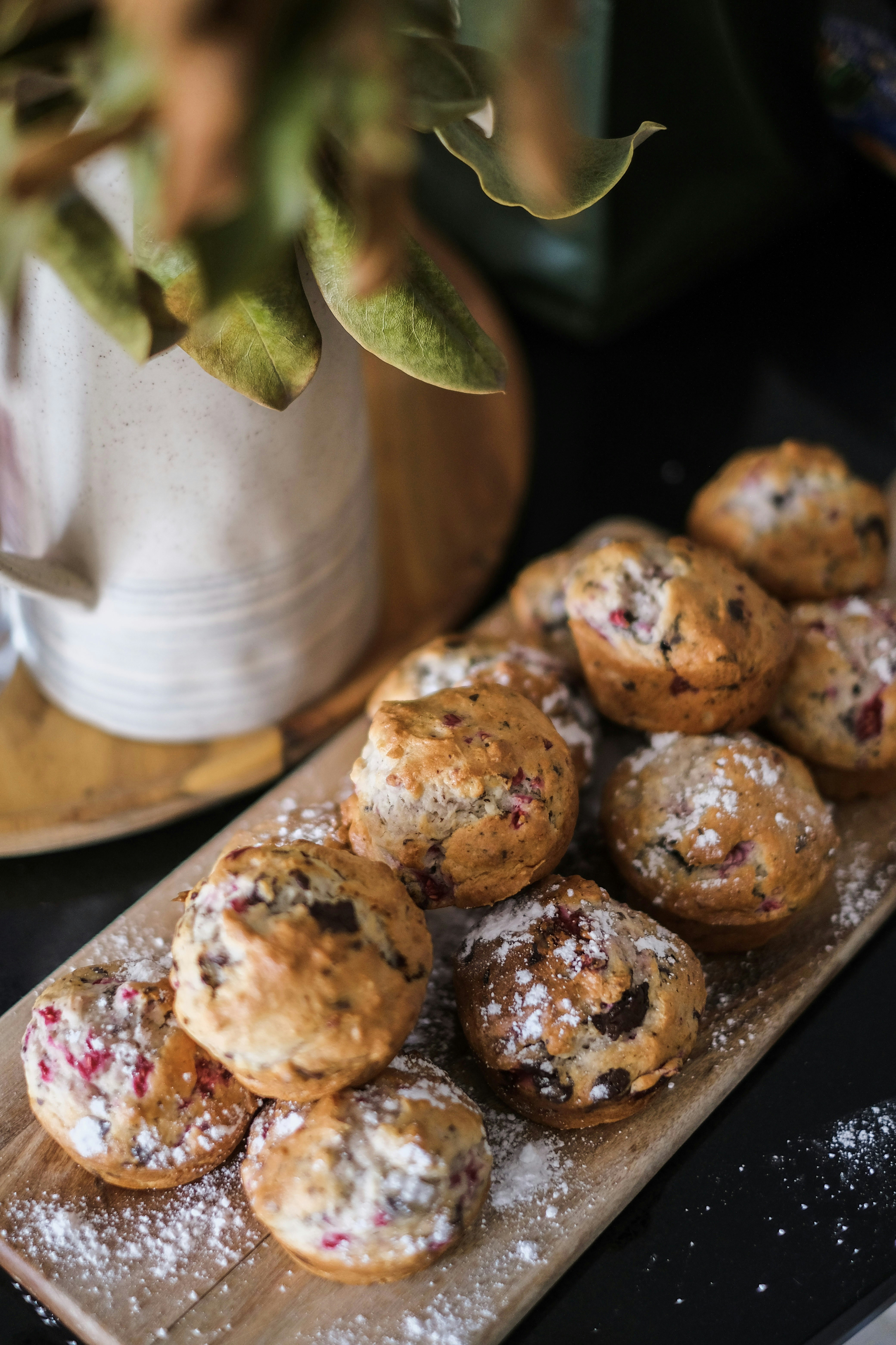 Sugared awakening: berry studded profiteroles on a wooden plank