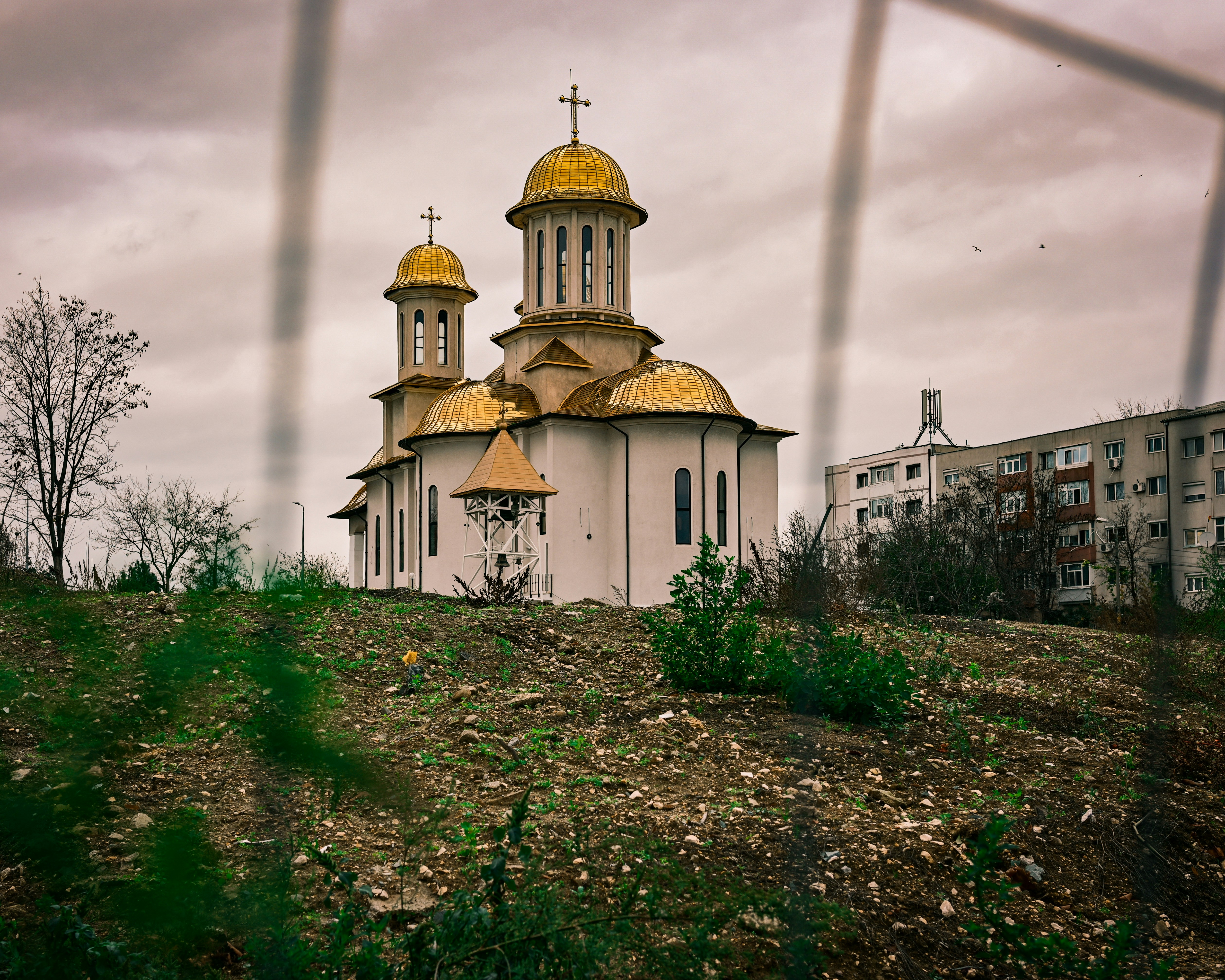Golden-Domed Church Rising Above A Ruined Field