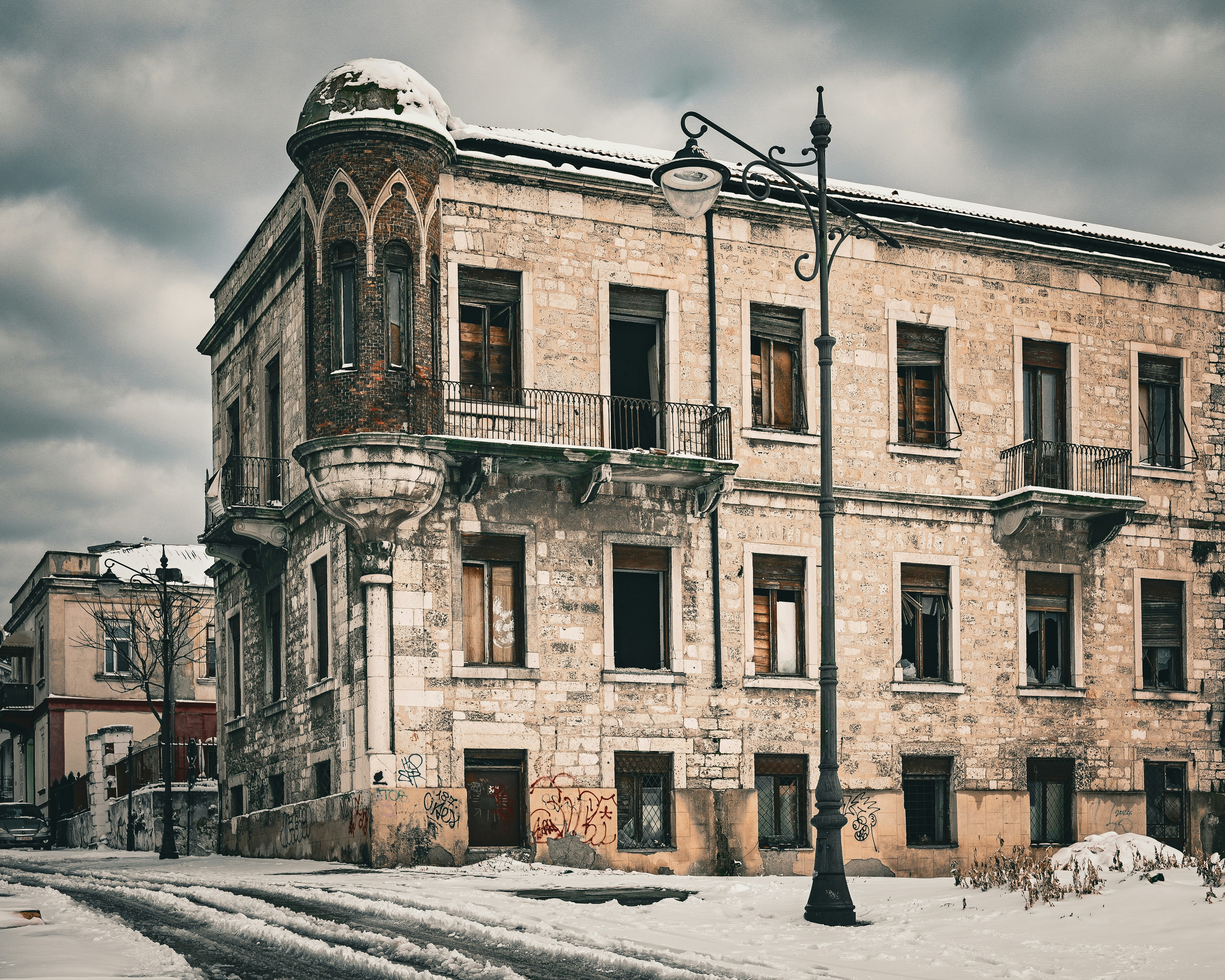 Winter Facade: A Corner Building Beneath a Slender Street Lamp