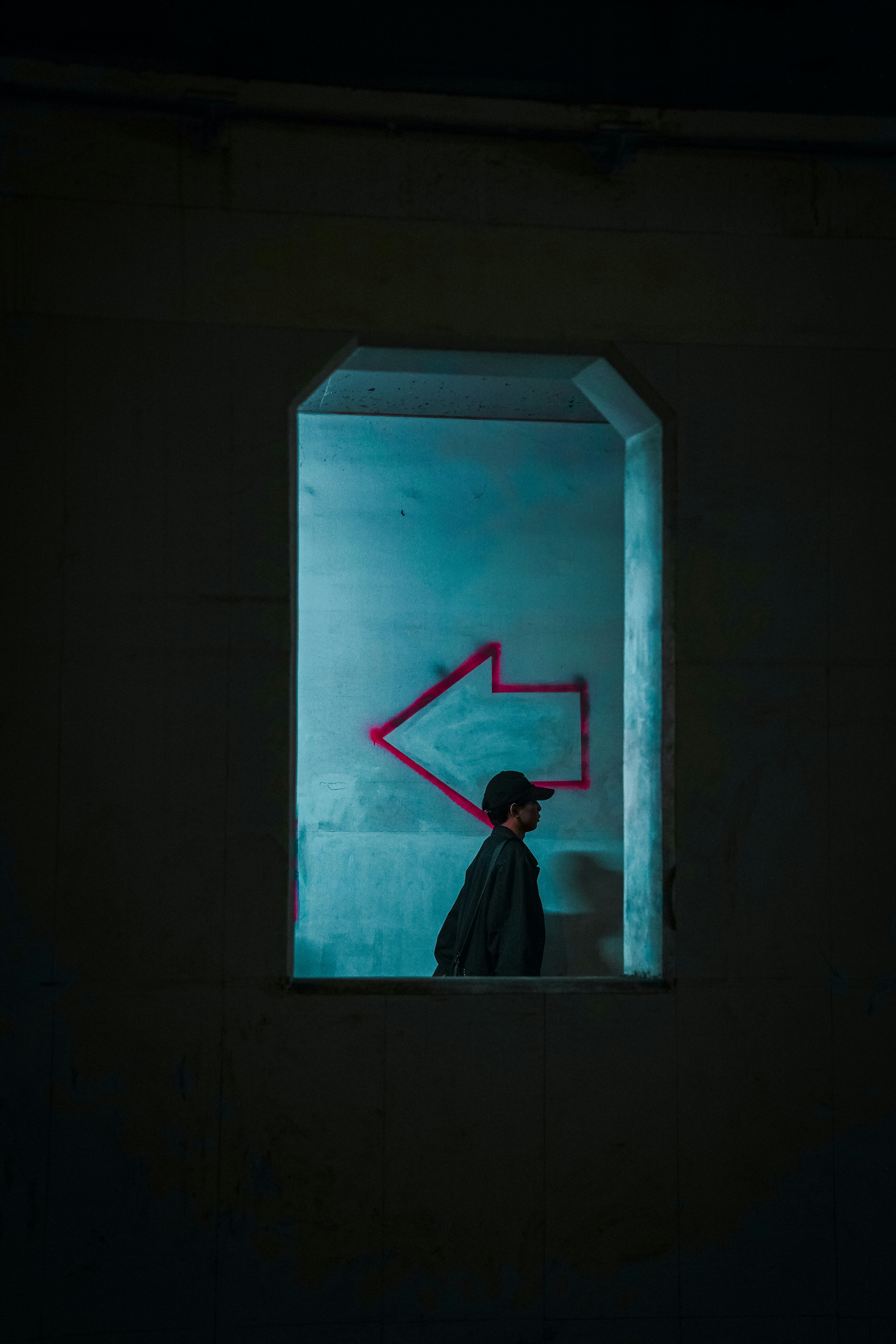 Through the Neon Arrow: A Silent Walk Past the Blue Wall