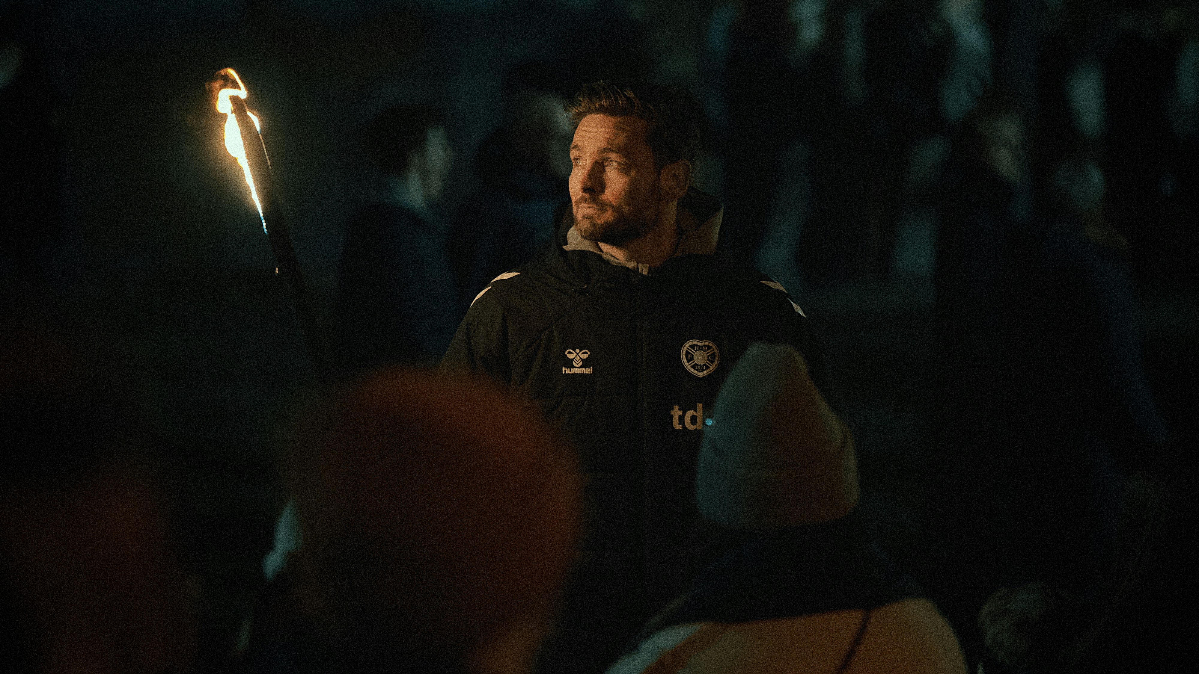 Torchlit Portrait in the Night Crowd