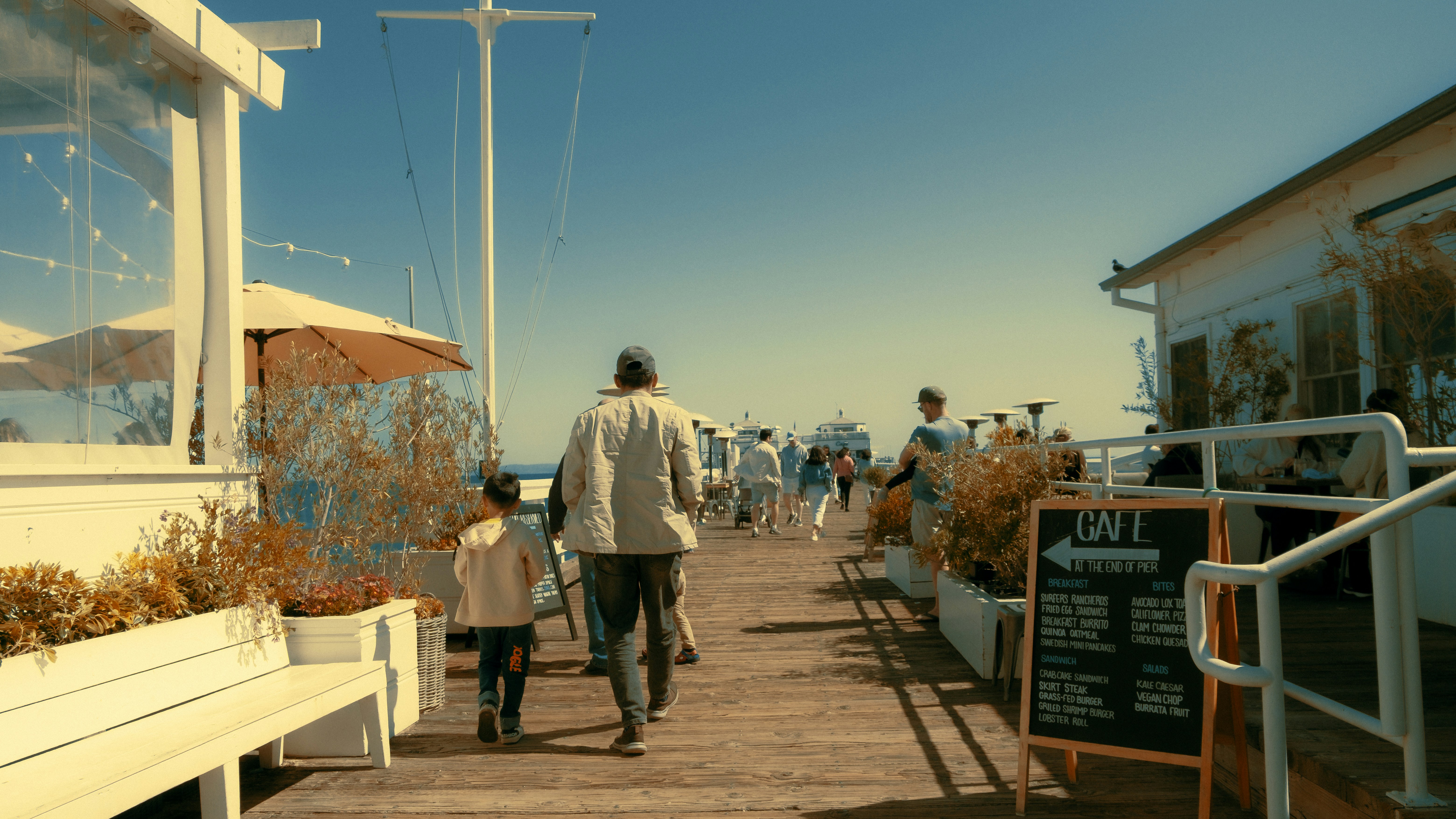 Boardwalk Stillness: A Family Walk Toward the Horizon