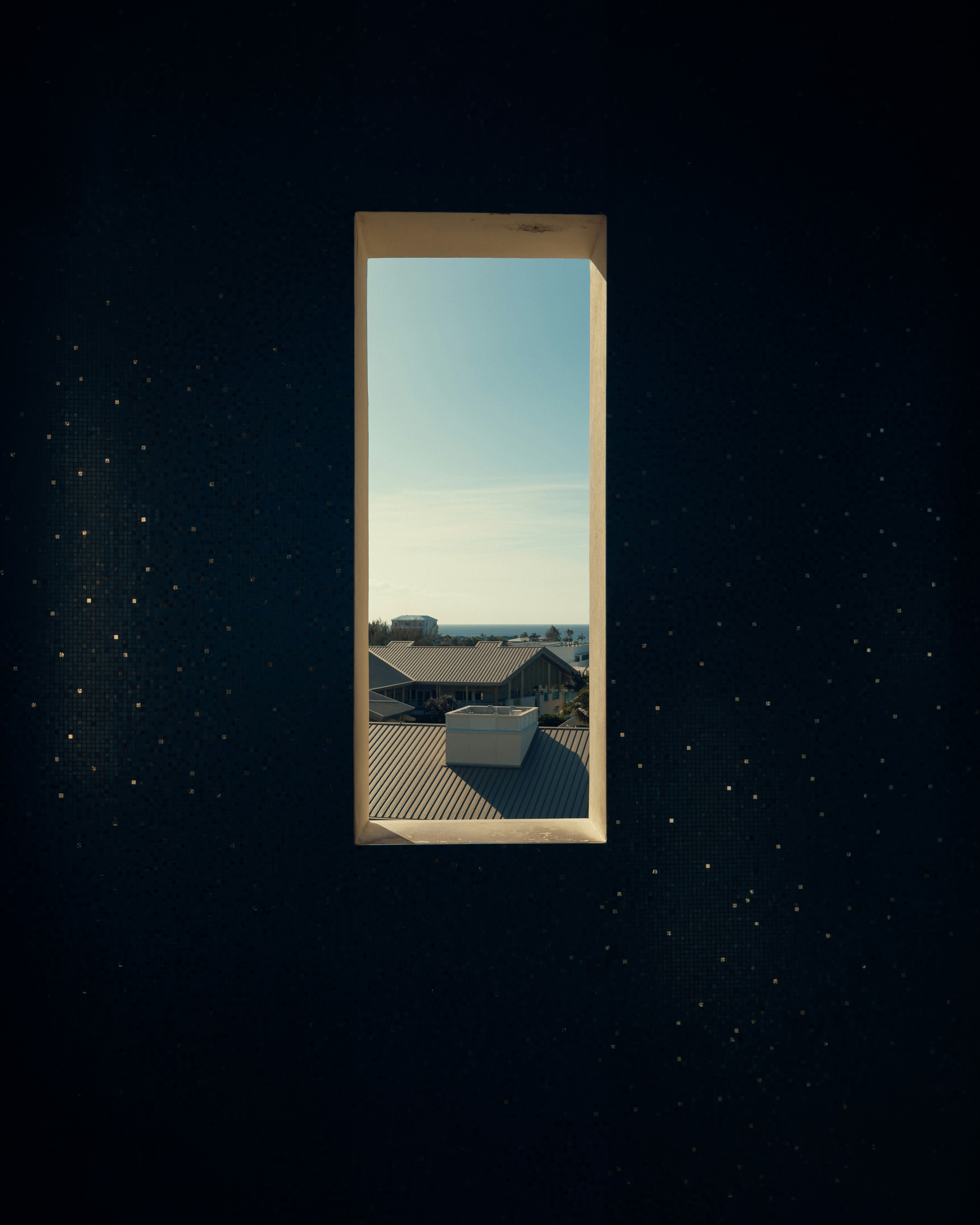 Through the Doorway to Daylight: Rooftops Framed by a Night Sky