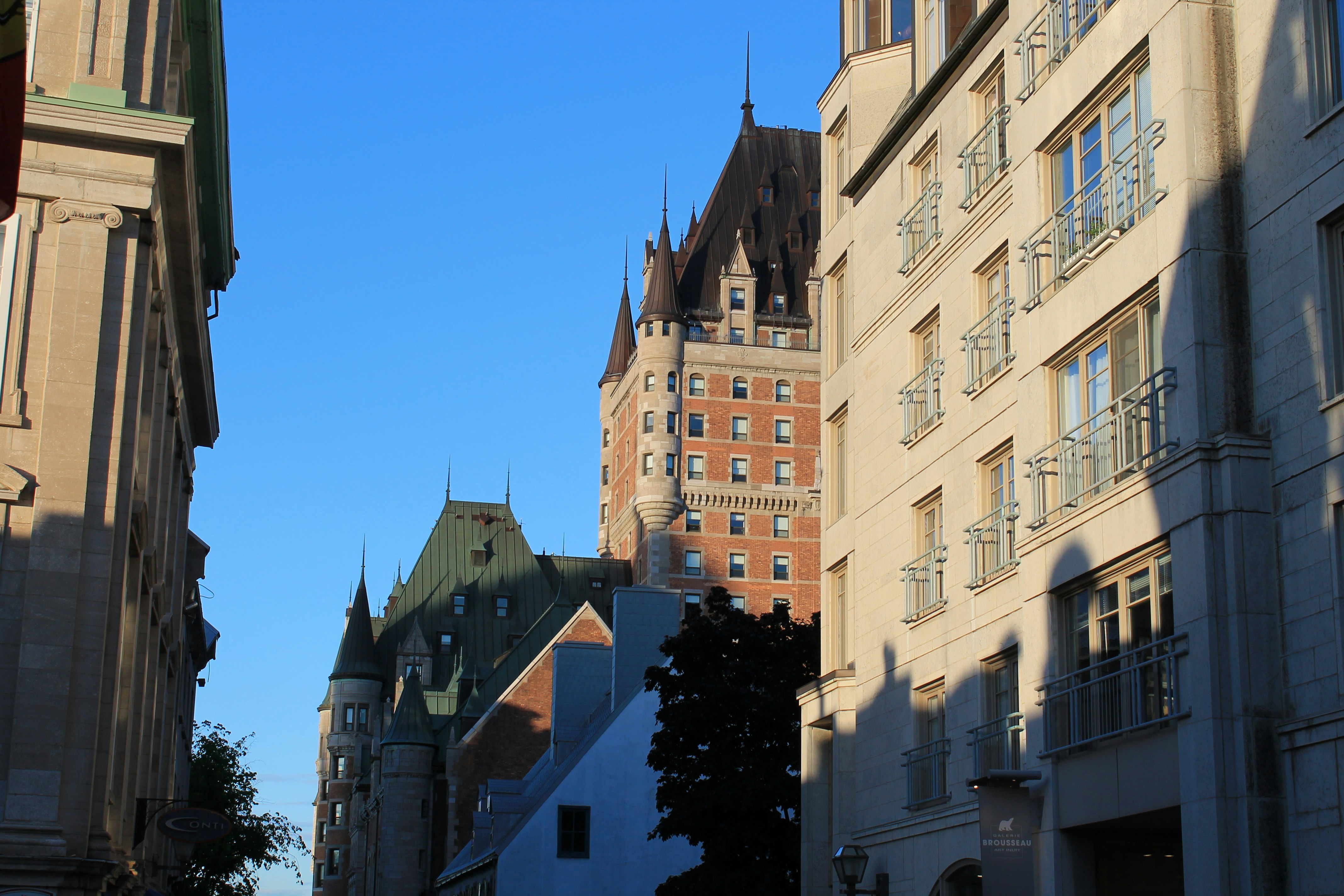 Urban Cathedral: Sunlit Towers Casting Long Shadows Down a Narrow Street