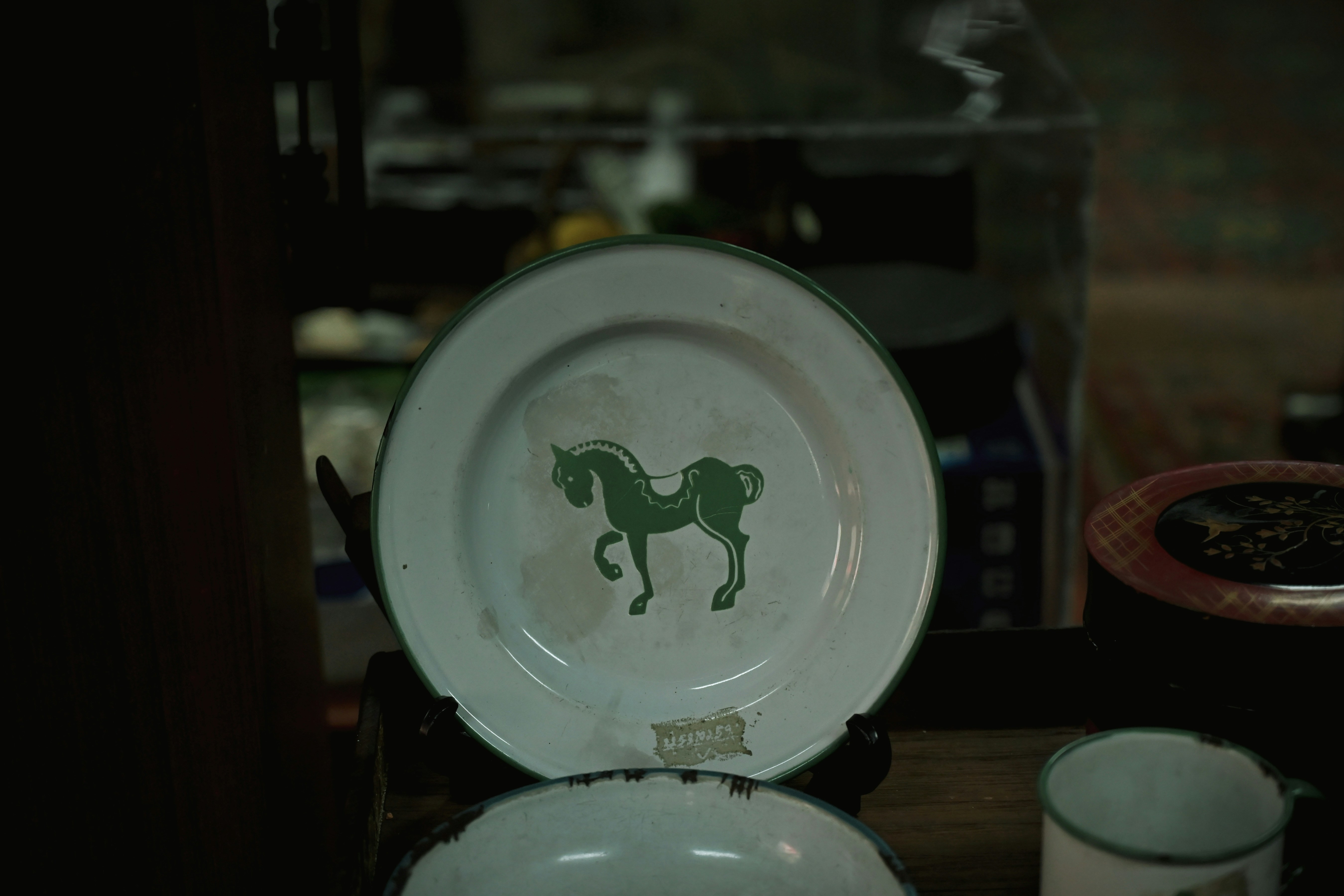 Green Mare on White: A Quiet Still Life Plate in a Dim Studio