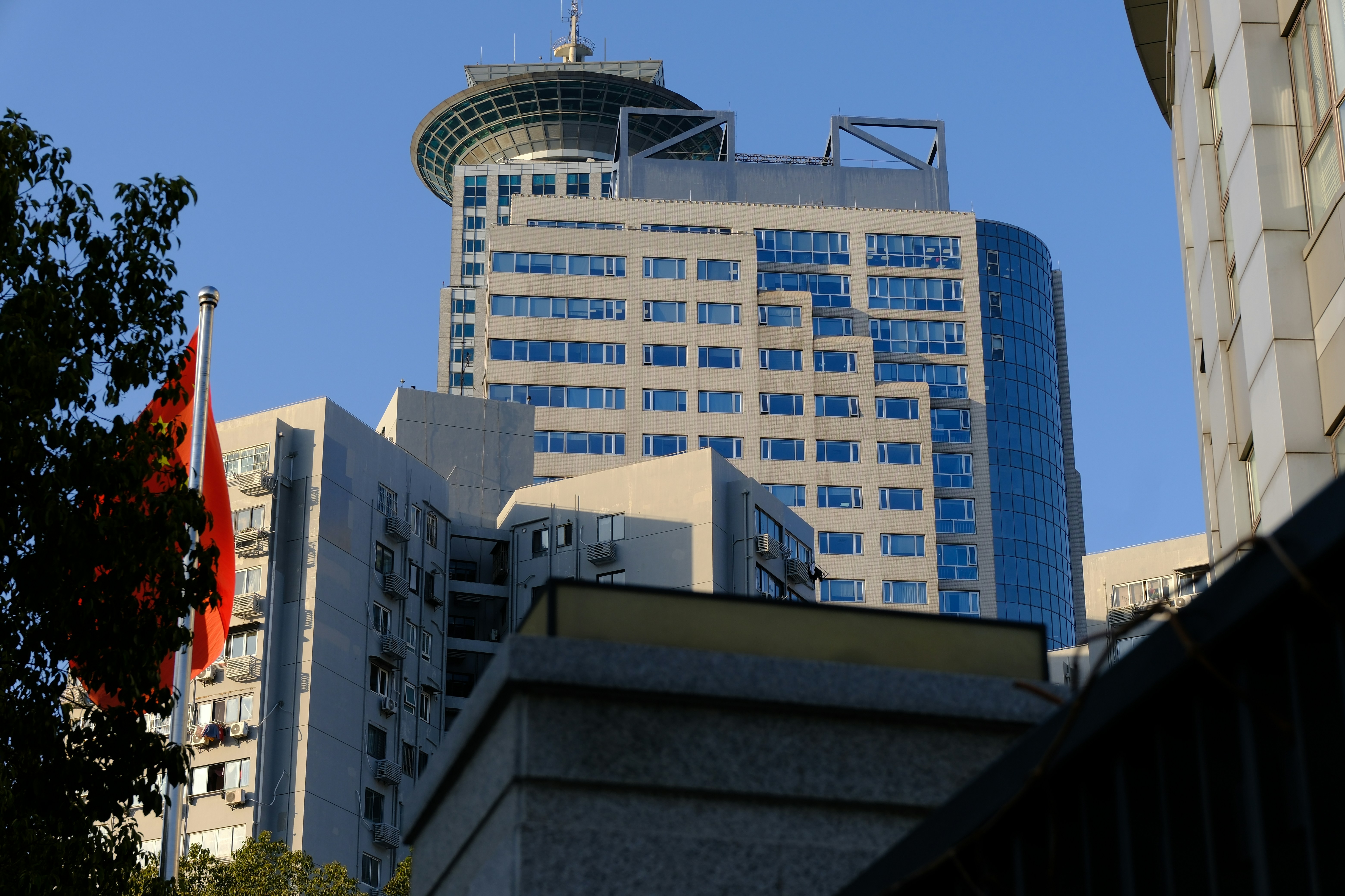 Skyline Tower with Circular Observation Deck Rises Above Urban Compose
