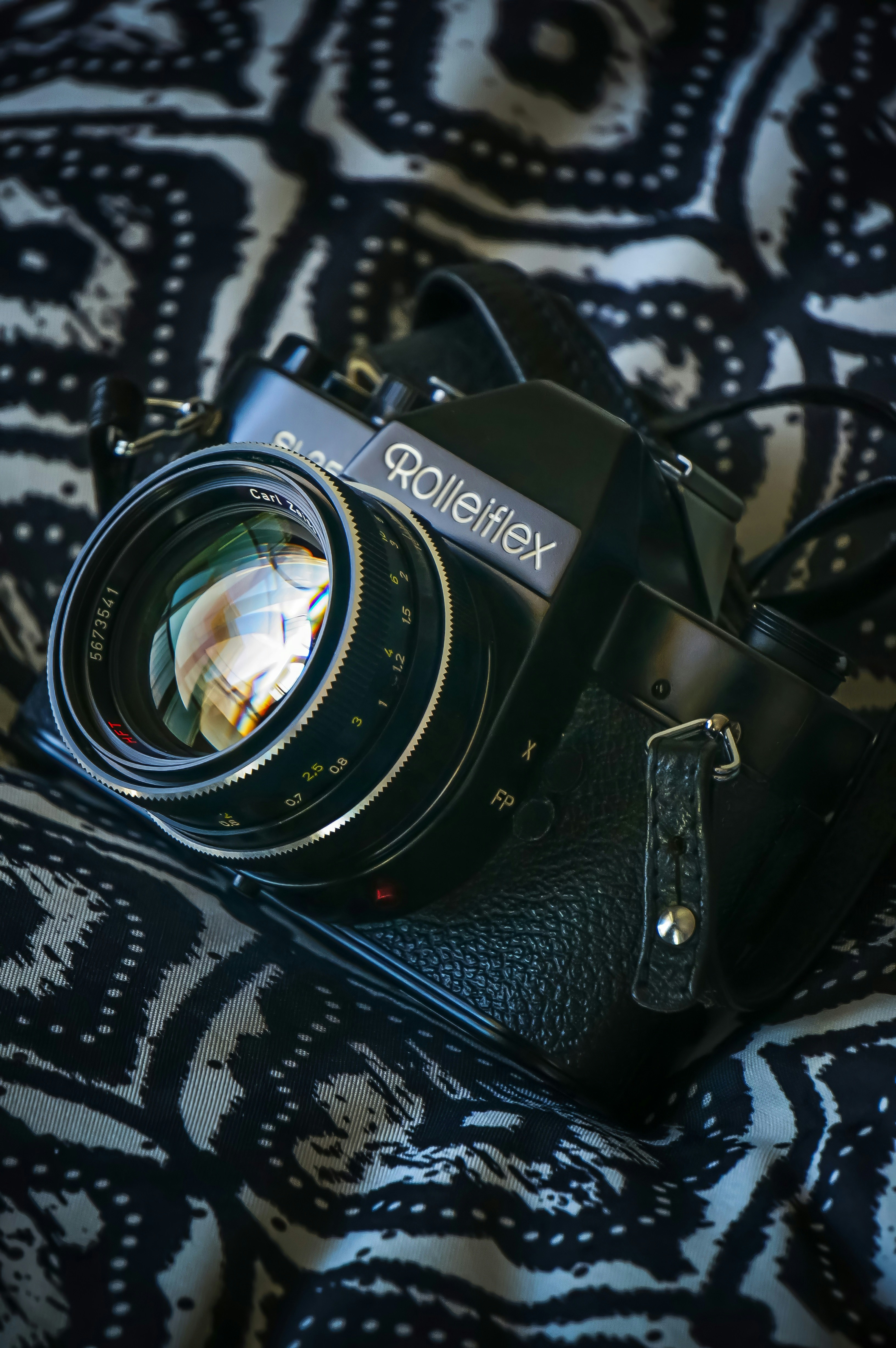 Rollei on Velvet: A Classic Camera Resting in Patterned Fabric