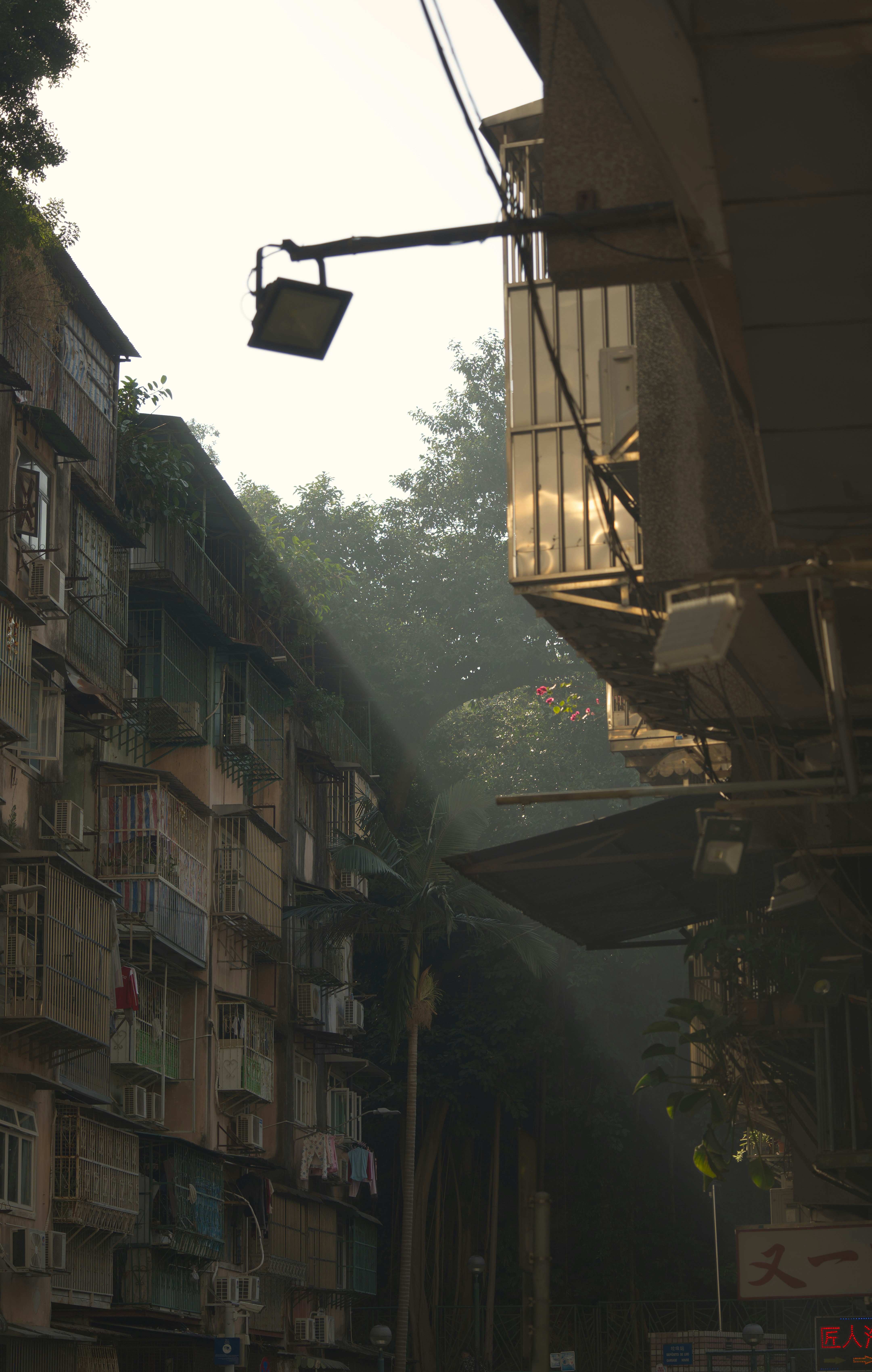 Sunlit Alley Between Cranes and Echoes of Laundry