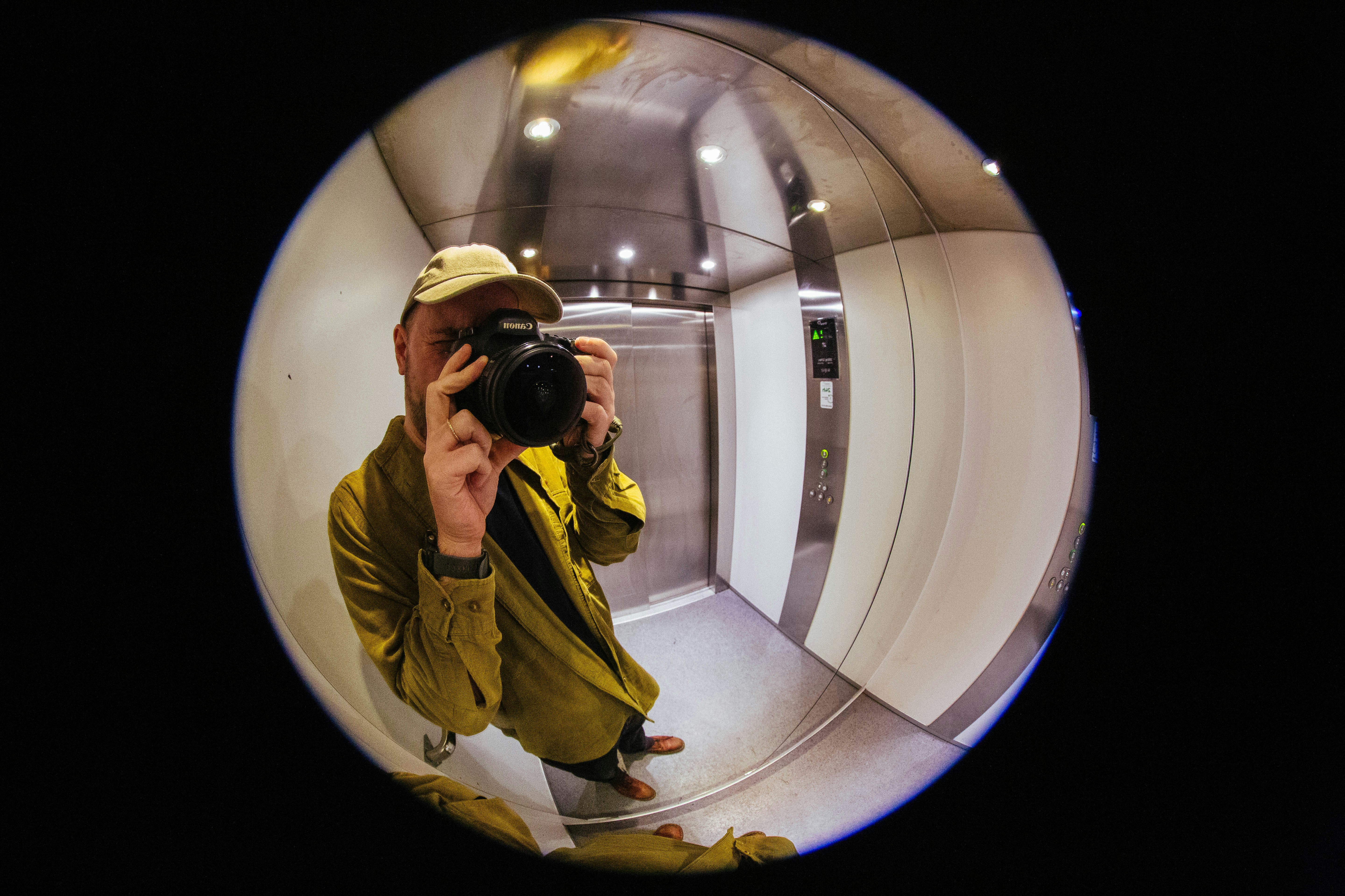 Mirror Orbit: The Photographer in a Circular Elevator