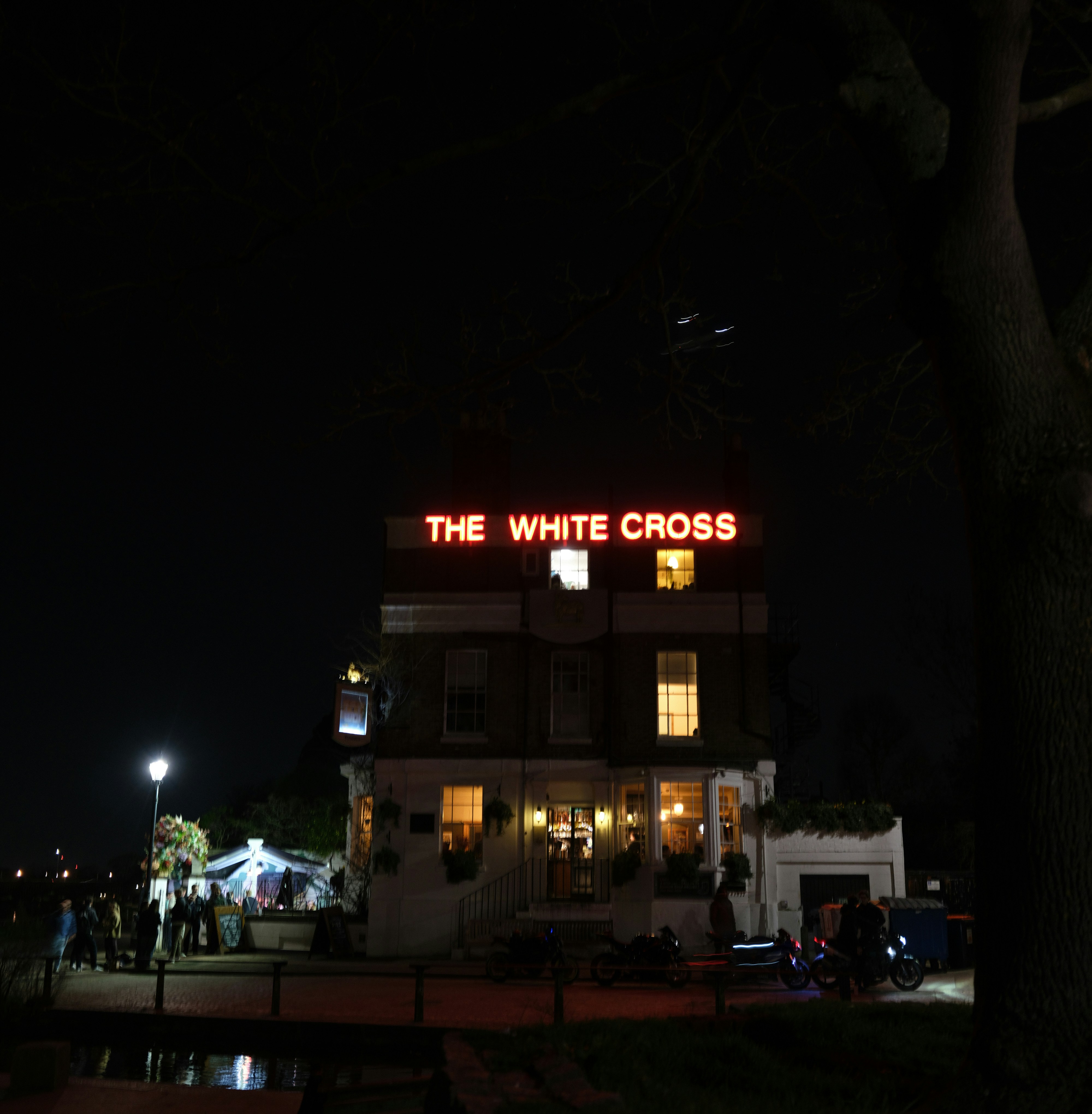 Neon Sign Over a Quiet Night at The White Cross