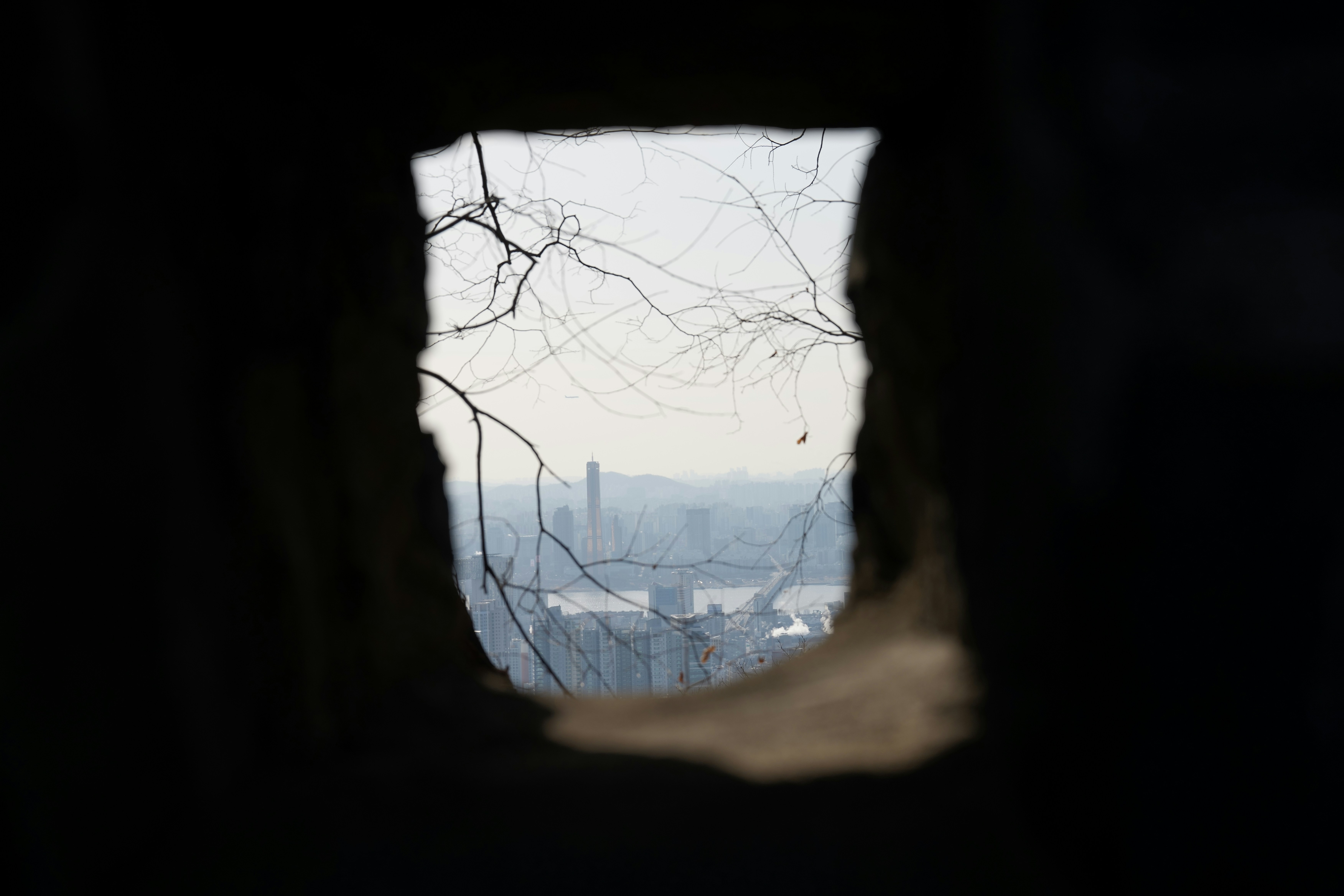 Cityscape Through a Framed Window of Darkness