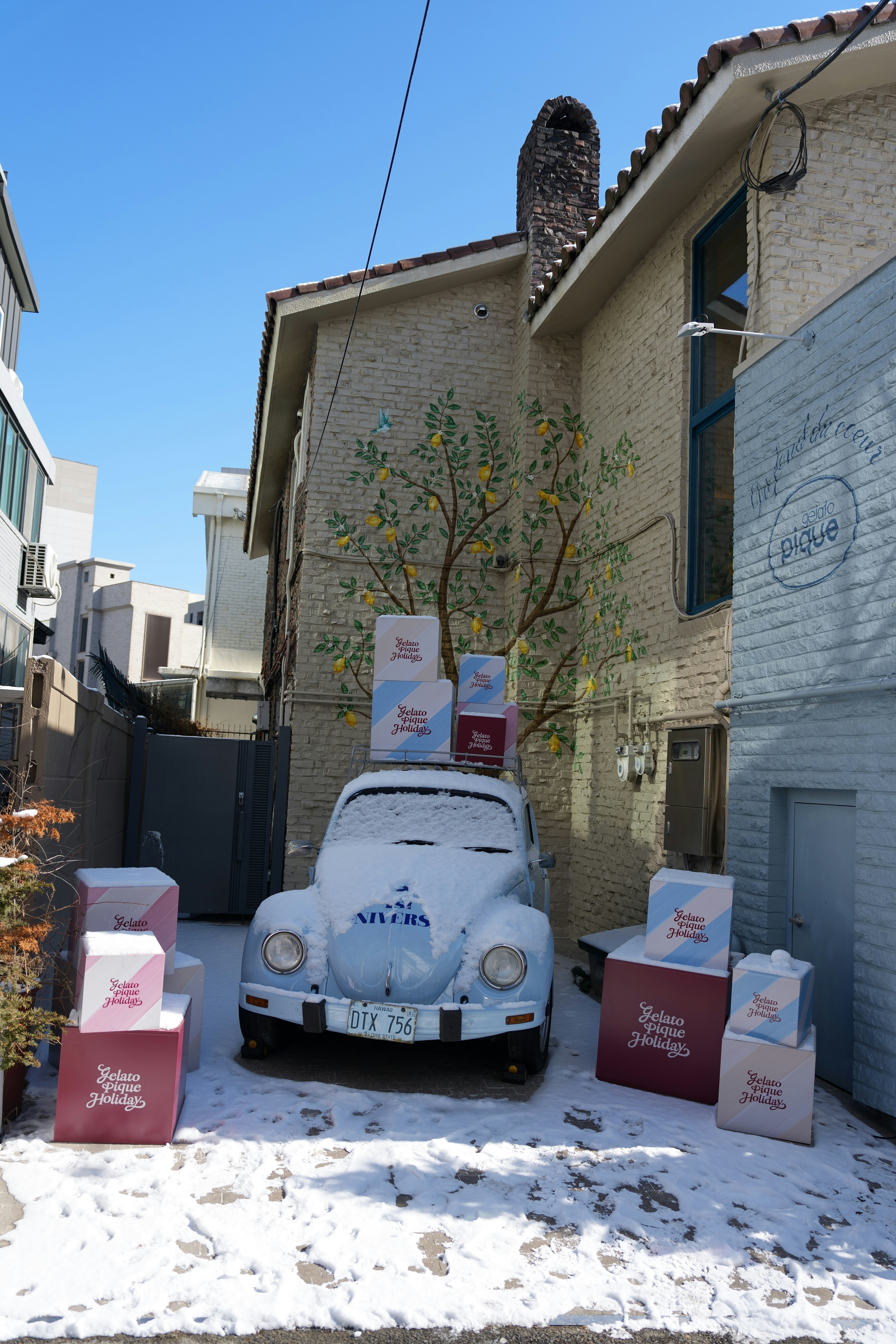 Snow-Covered Volkswagen Surprise: Boxes, Car, and a Cozy Courtyard