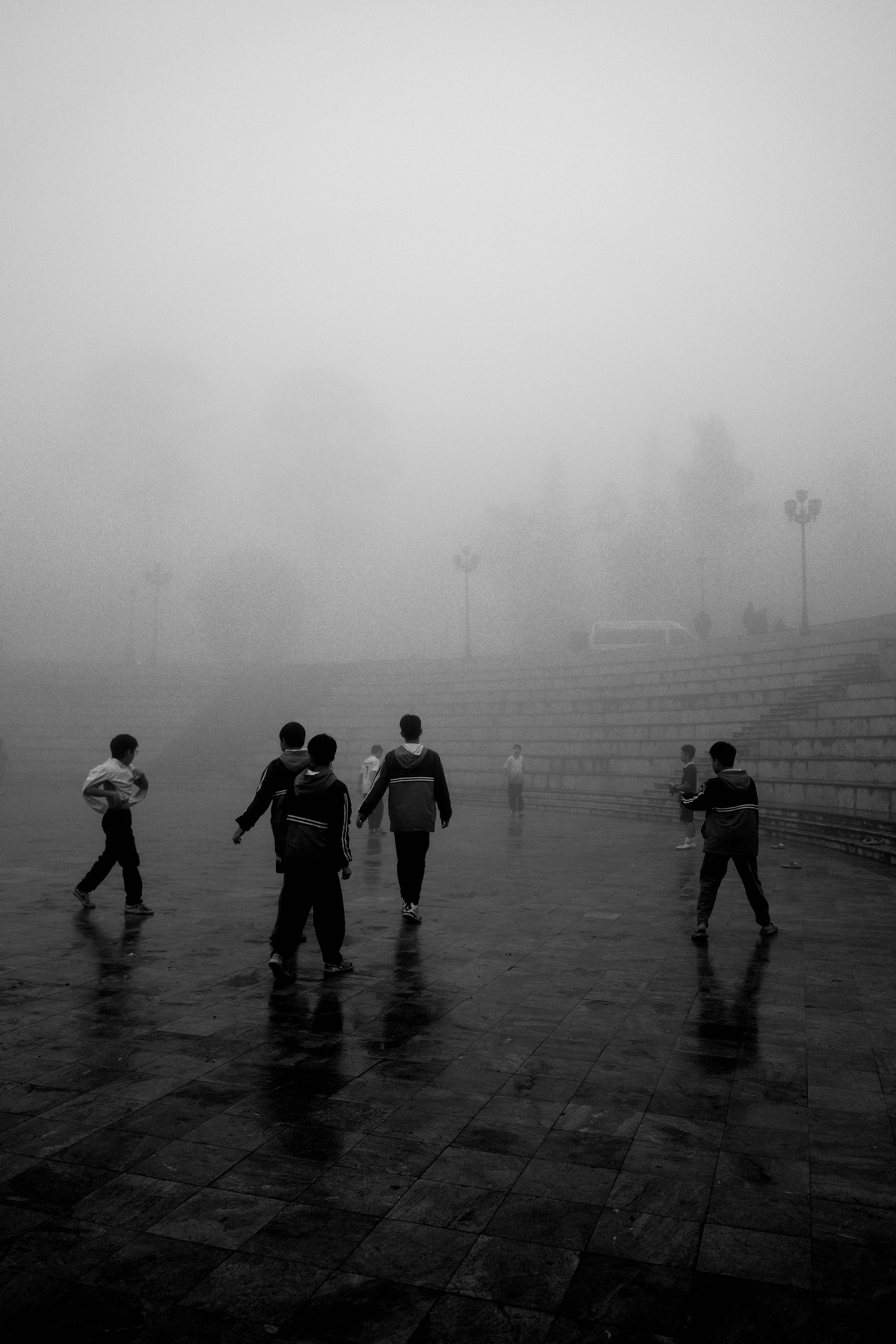 Figures in Fog: A Quiet Convergence on the Wet Plaza