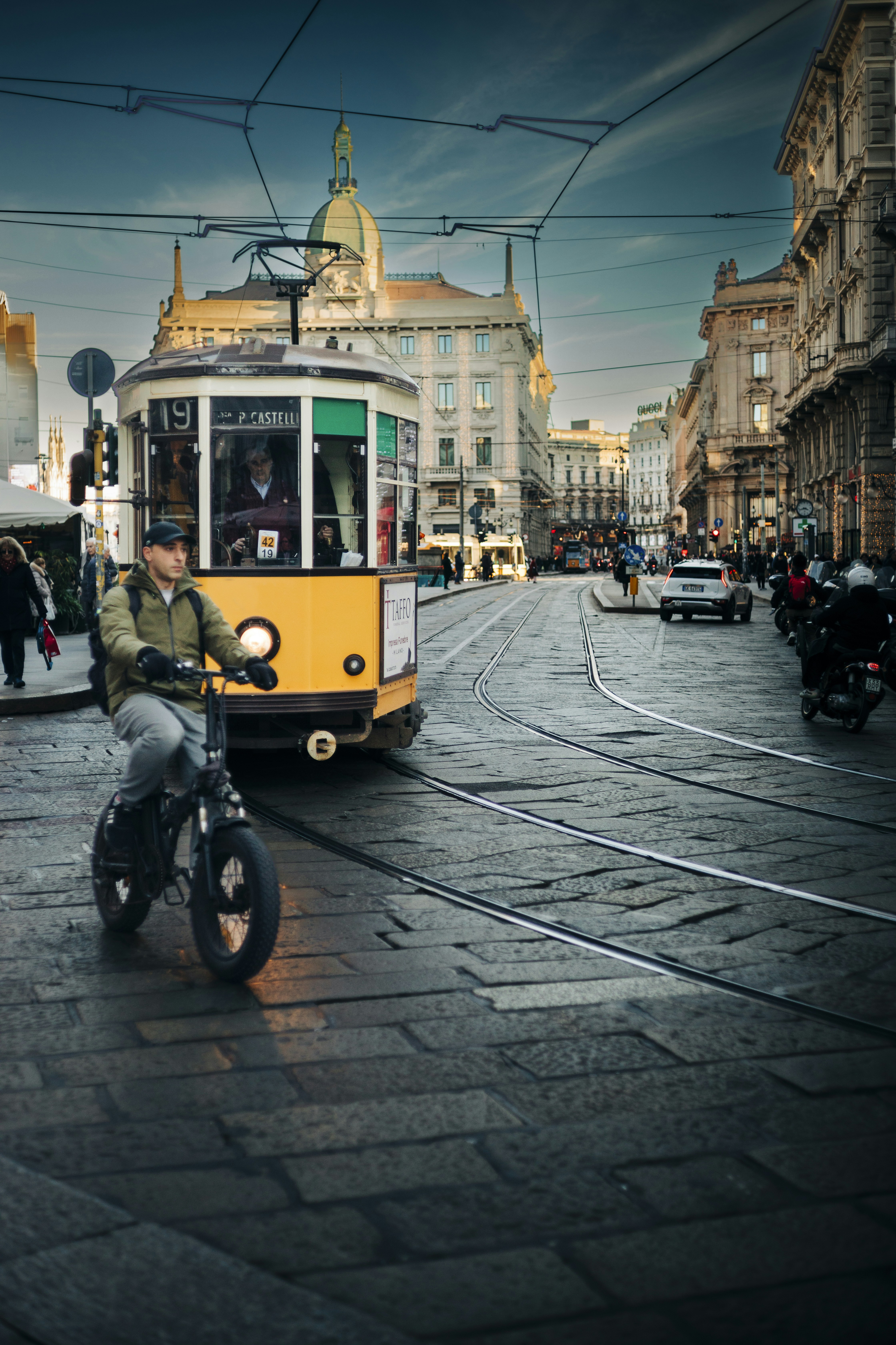 Yellow Streetcar in Focus: City Pulse on a Cobblestone Morning