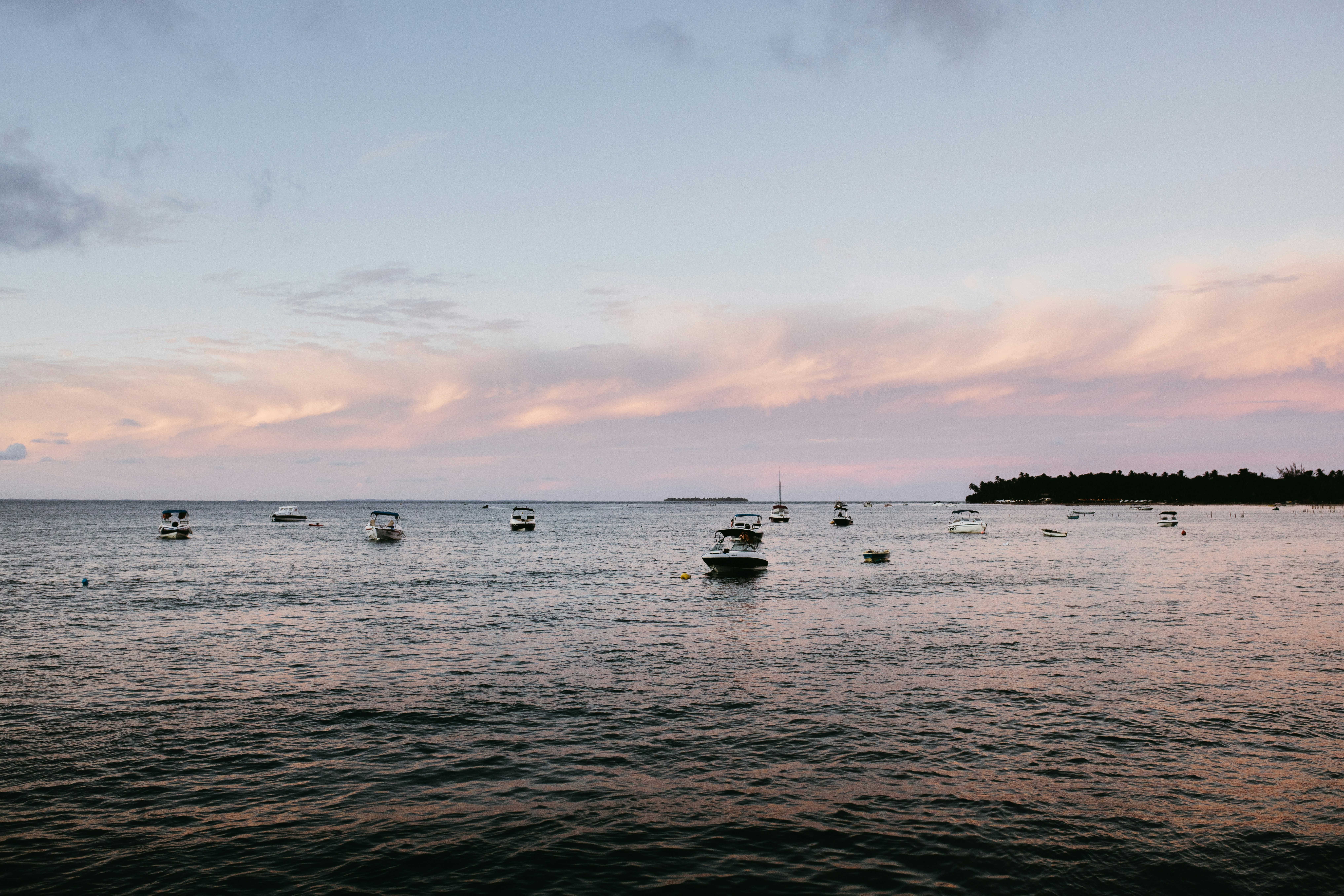 Sunset Harbor: Boats Whisper Across a Calm Inland Sea