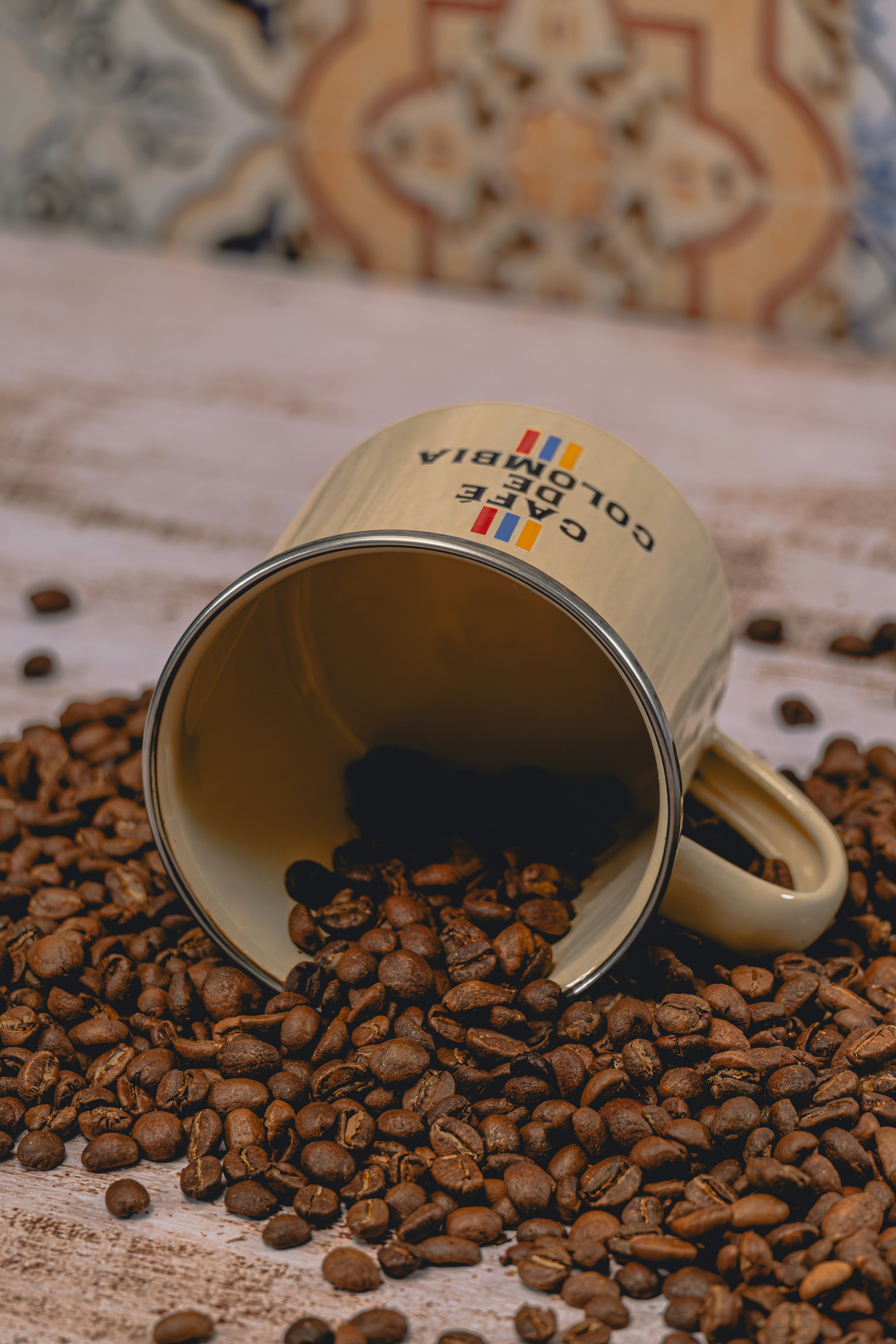 Spilled Warmth: A Coffee Mug Tipped Among Roasted Beans