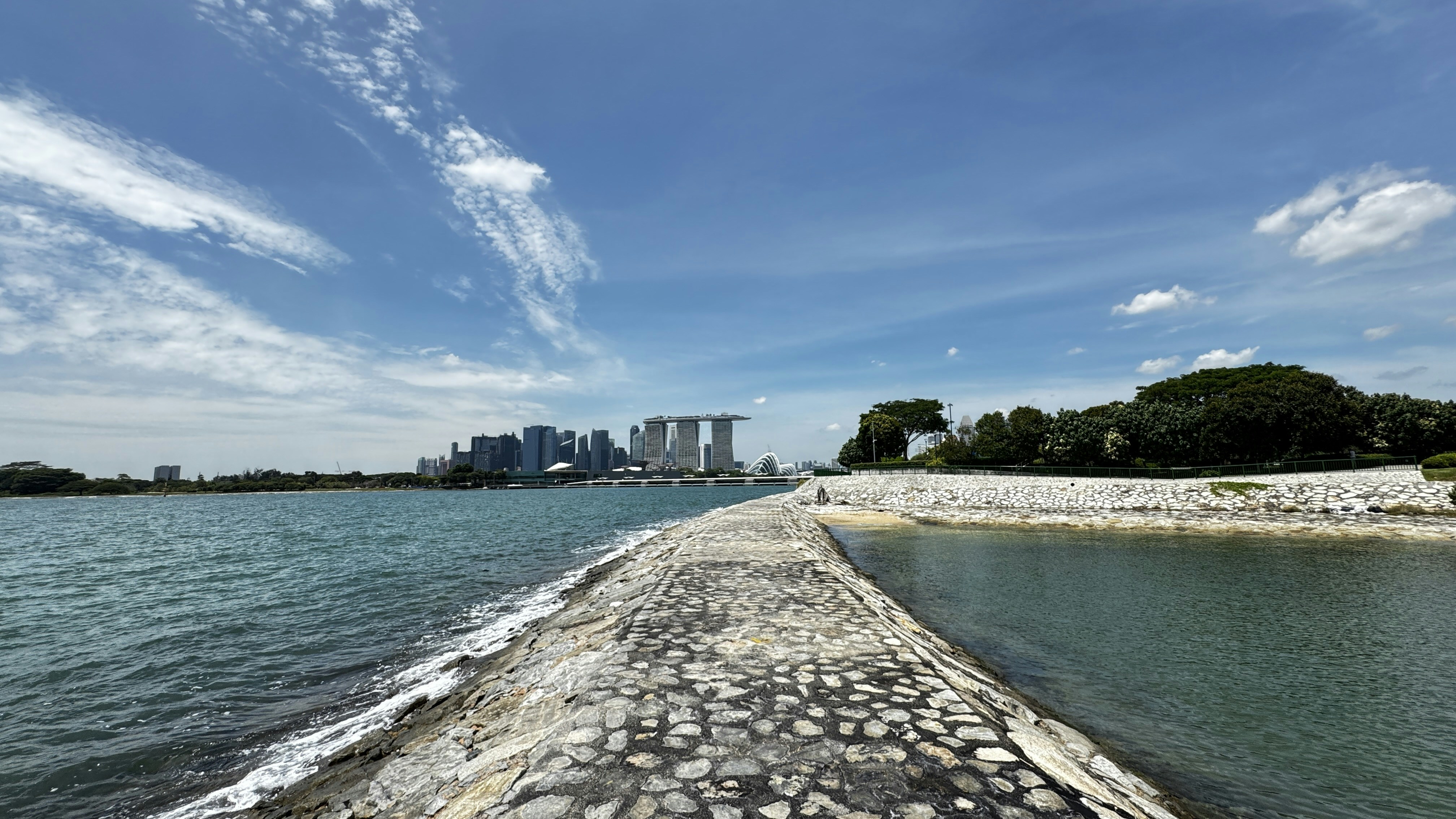 Stone Causeway to the Skyline: A Coastal Path Toward the City