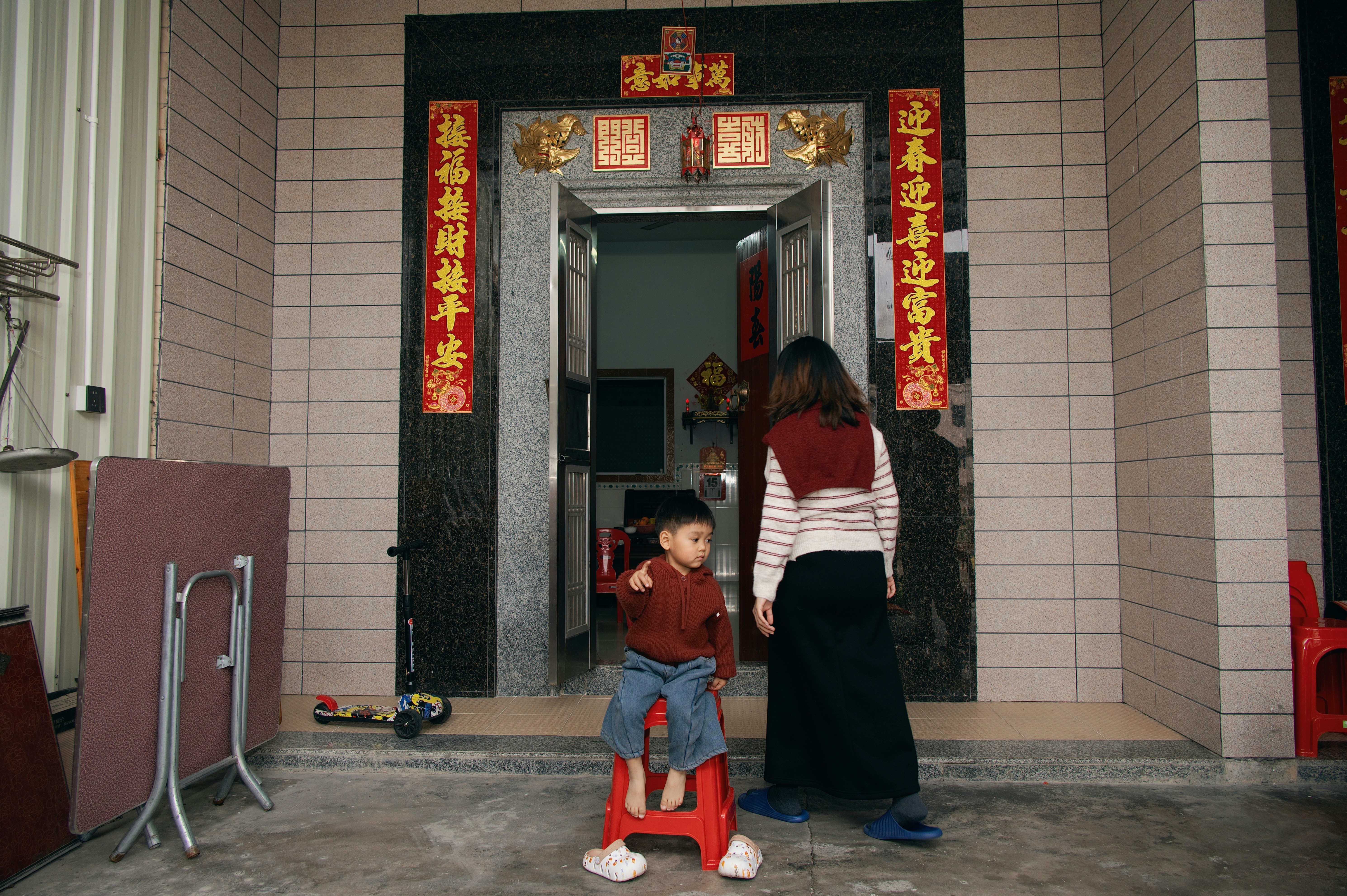 At the Threshold: A Quiet Moment Outside a Traditional Temple Entrance