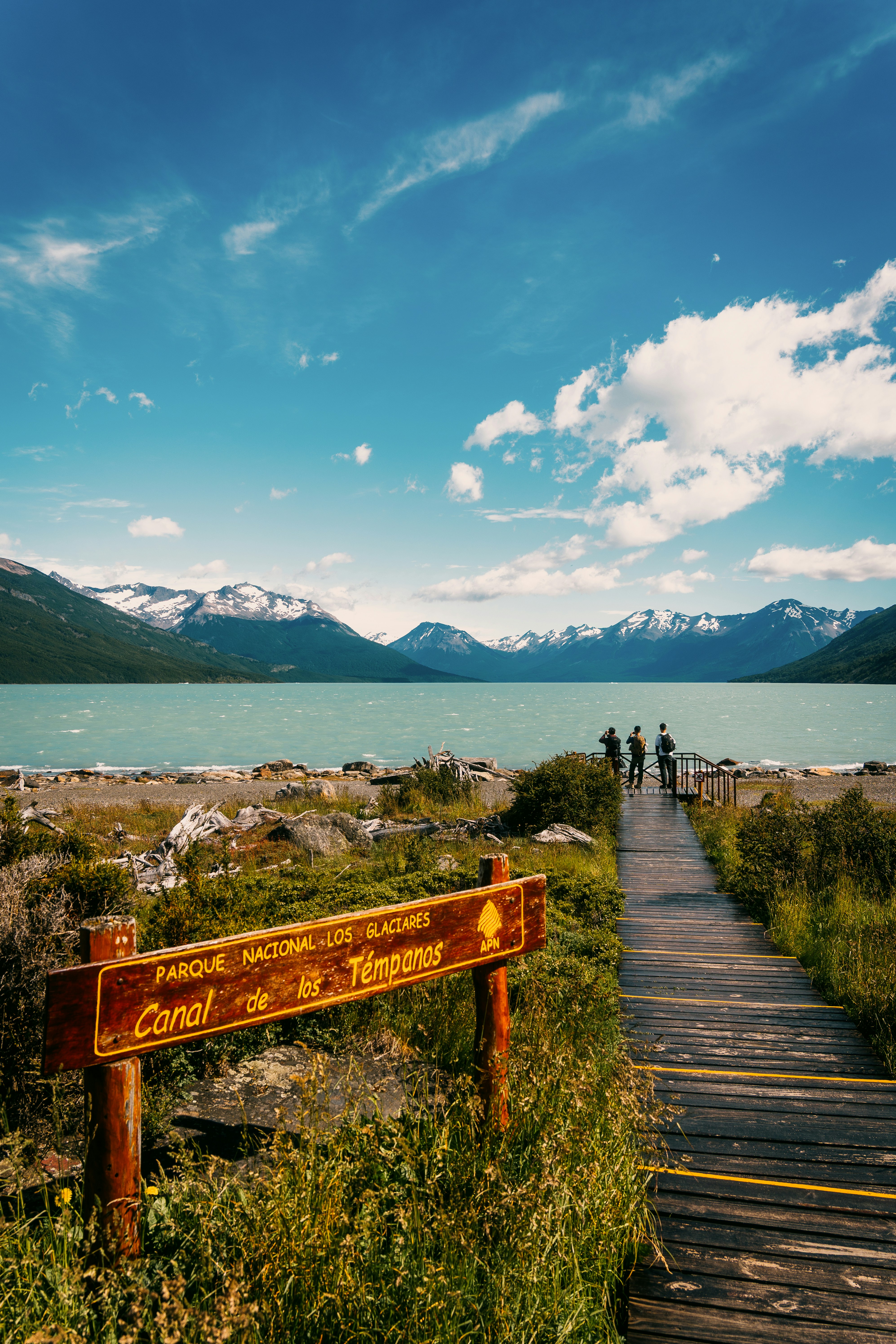 Bridge to a Glacier Lake: People on the Boardwalk at Distant Shore