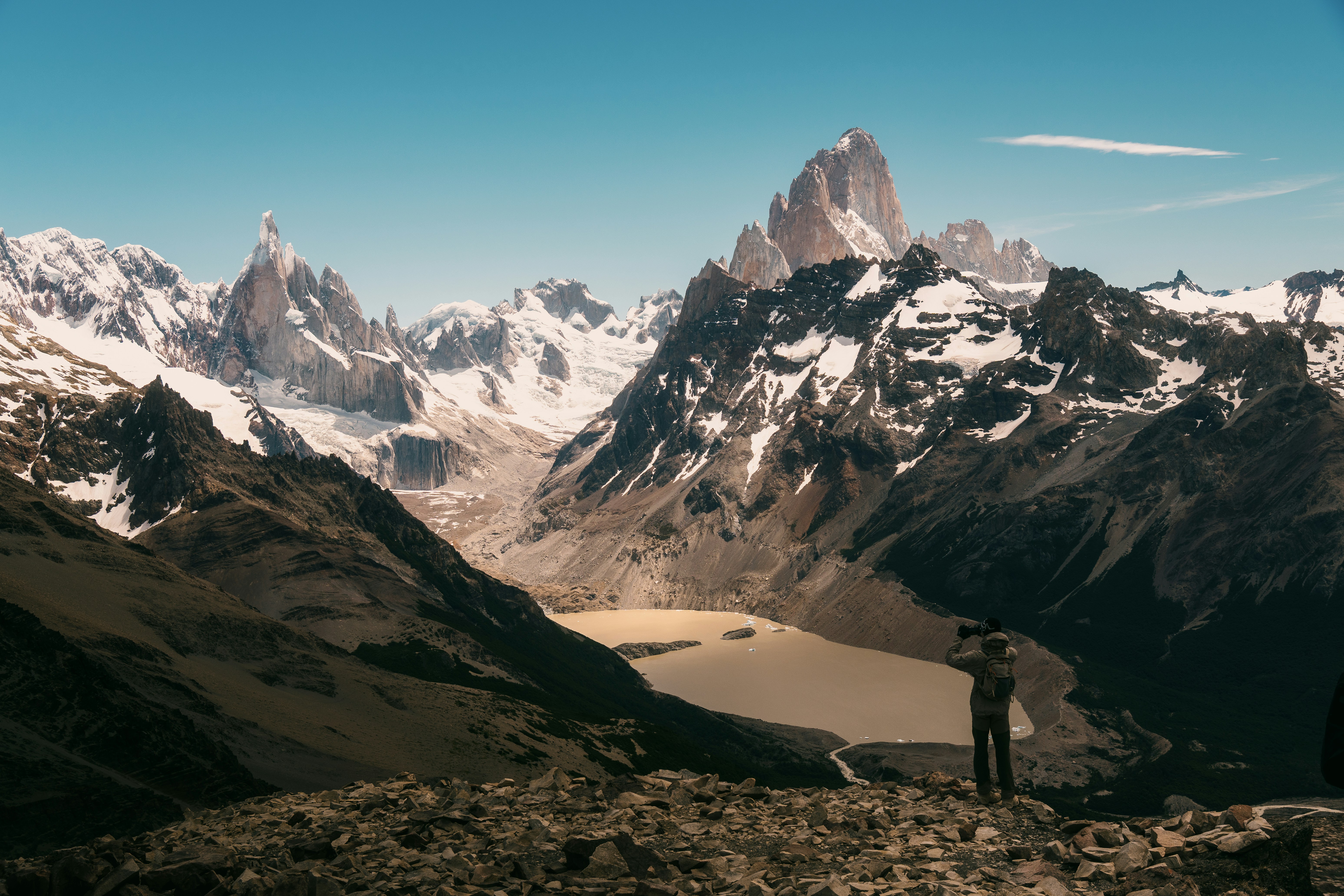 A Granite Summit: Lone Explorer Beneath Alpine Giants