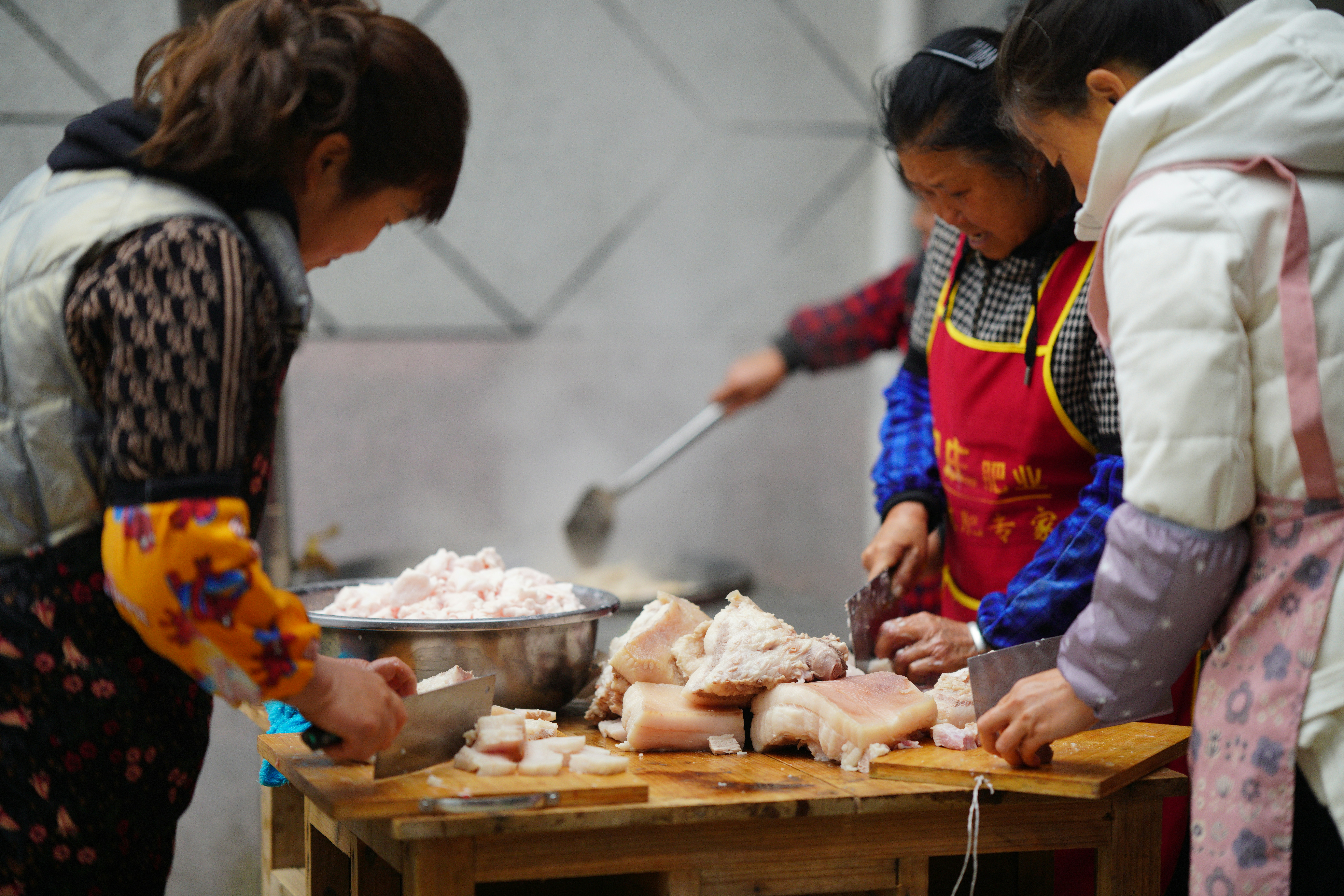 Street Kitchen: Hands at Work Preparing Pork on Wooden Board