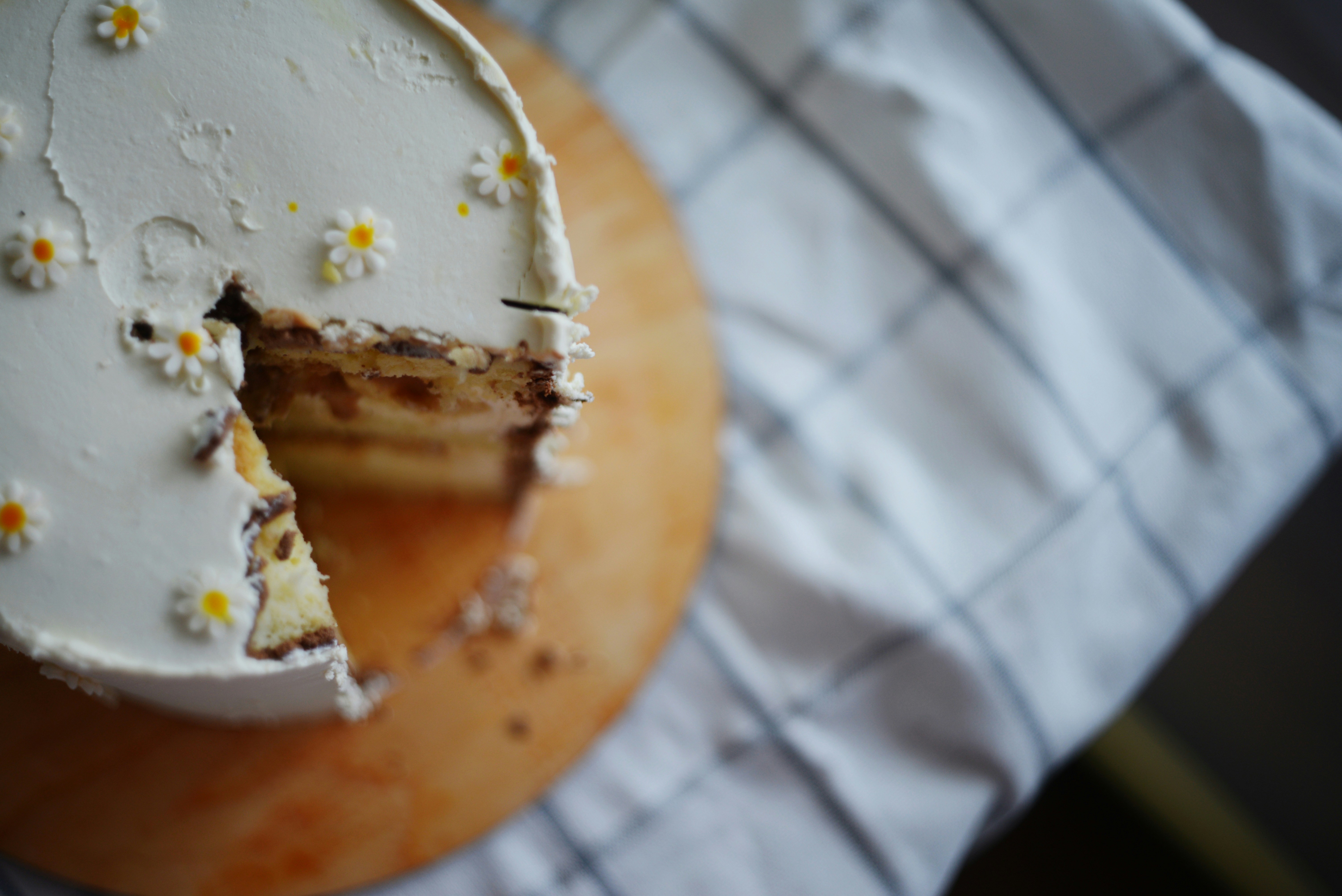 Slice of Vanilla Secrets: A Partial Cake with Floral Frosting