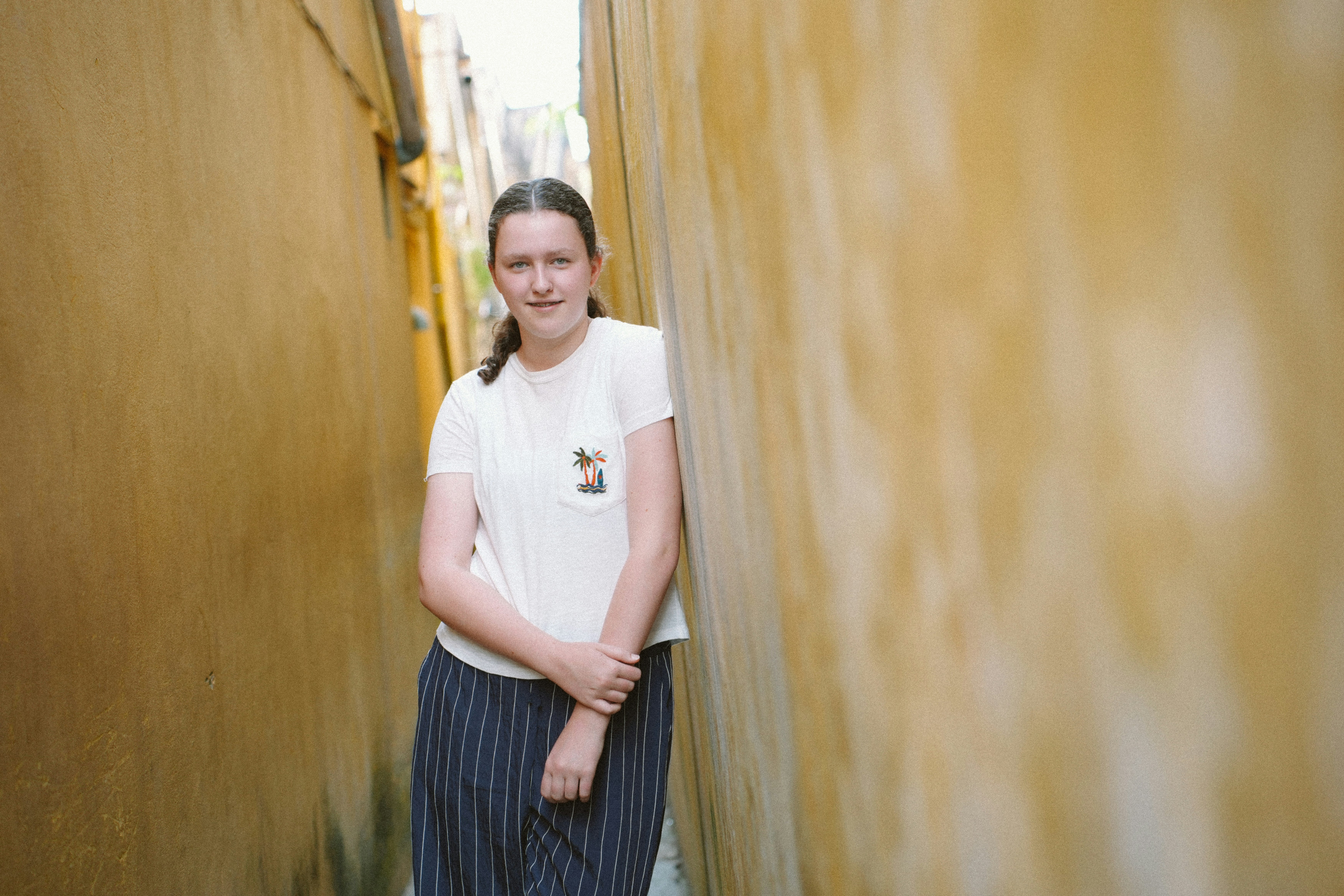 Between Golden Walls: A Quiet Portrait in a Narrow Alley