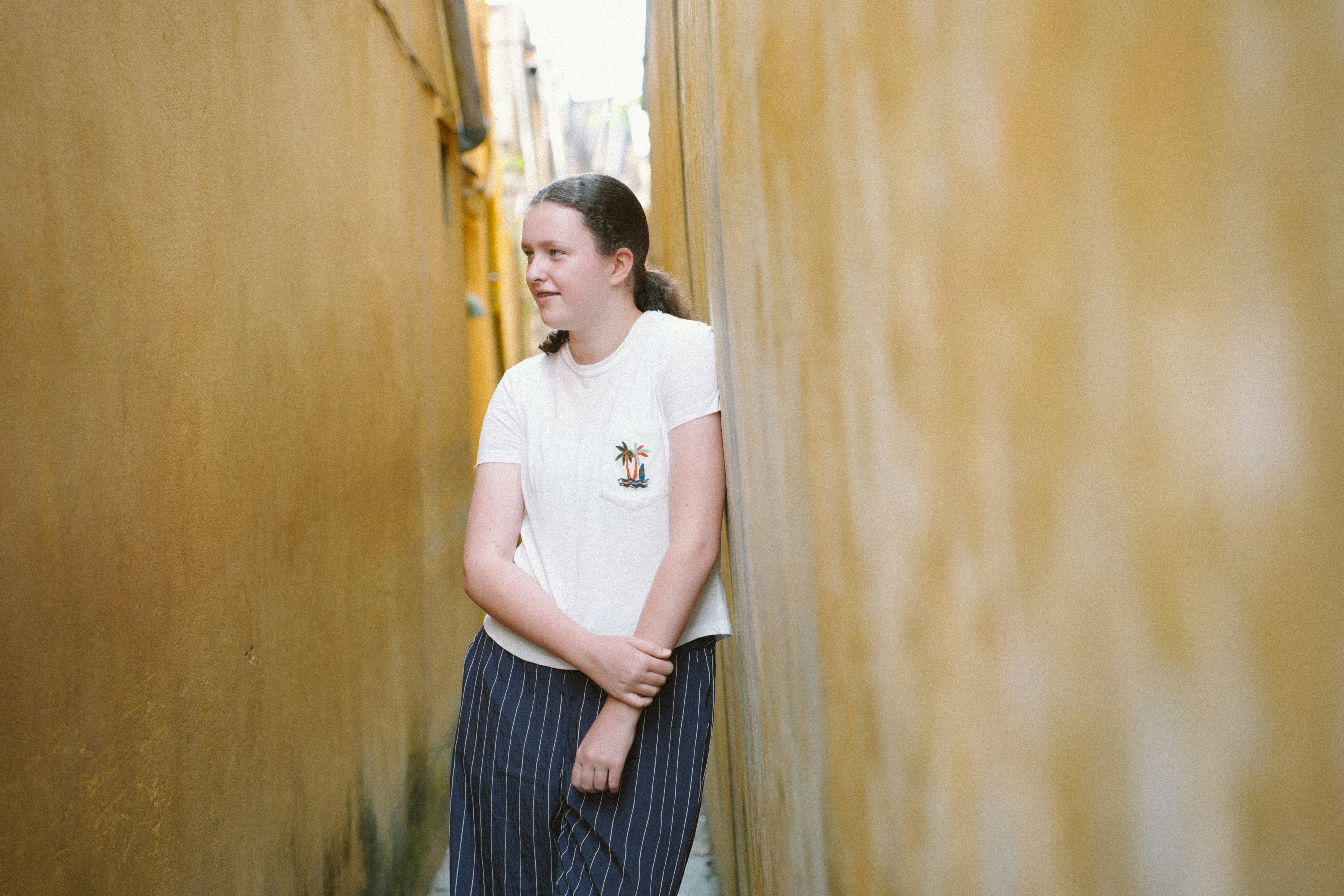 Between Narrow Walls: A Quiet Moment in a Golden Alley