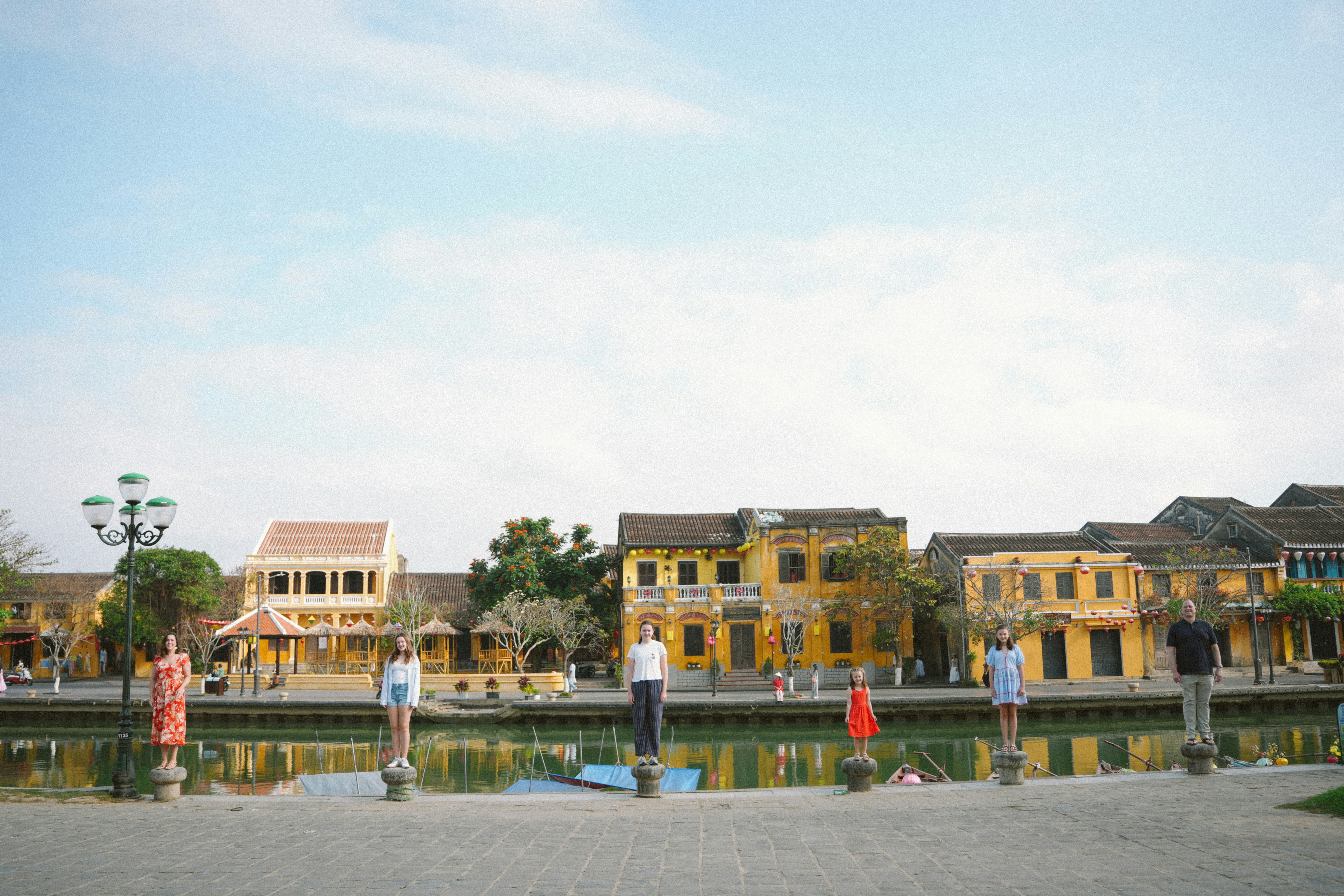 Riverfront Piazza: A Row of Colorful Old Town Buildings Reflecting in Calm Waters