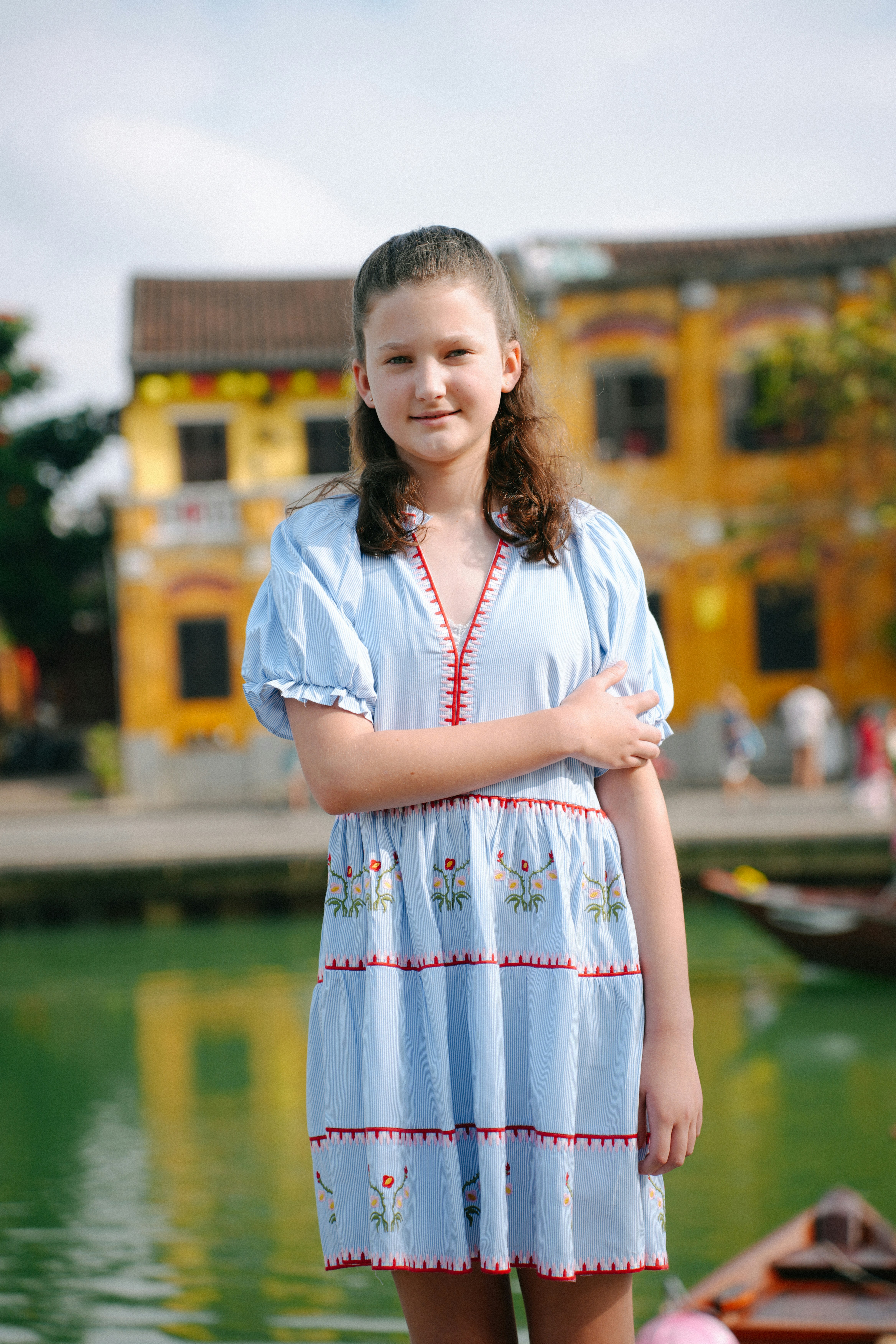 Youthful Portrait by a Riverside Village Street