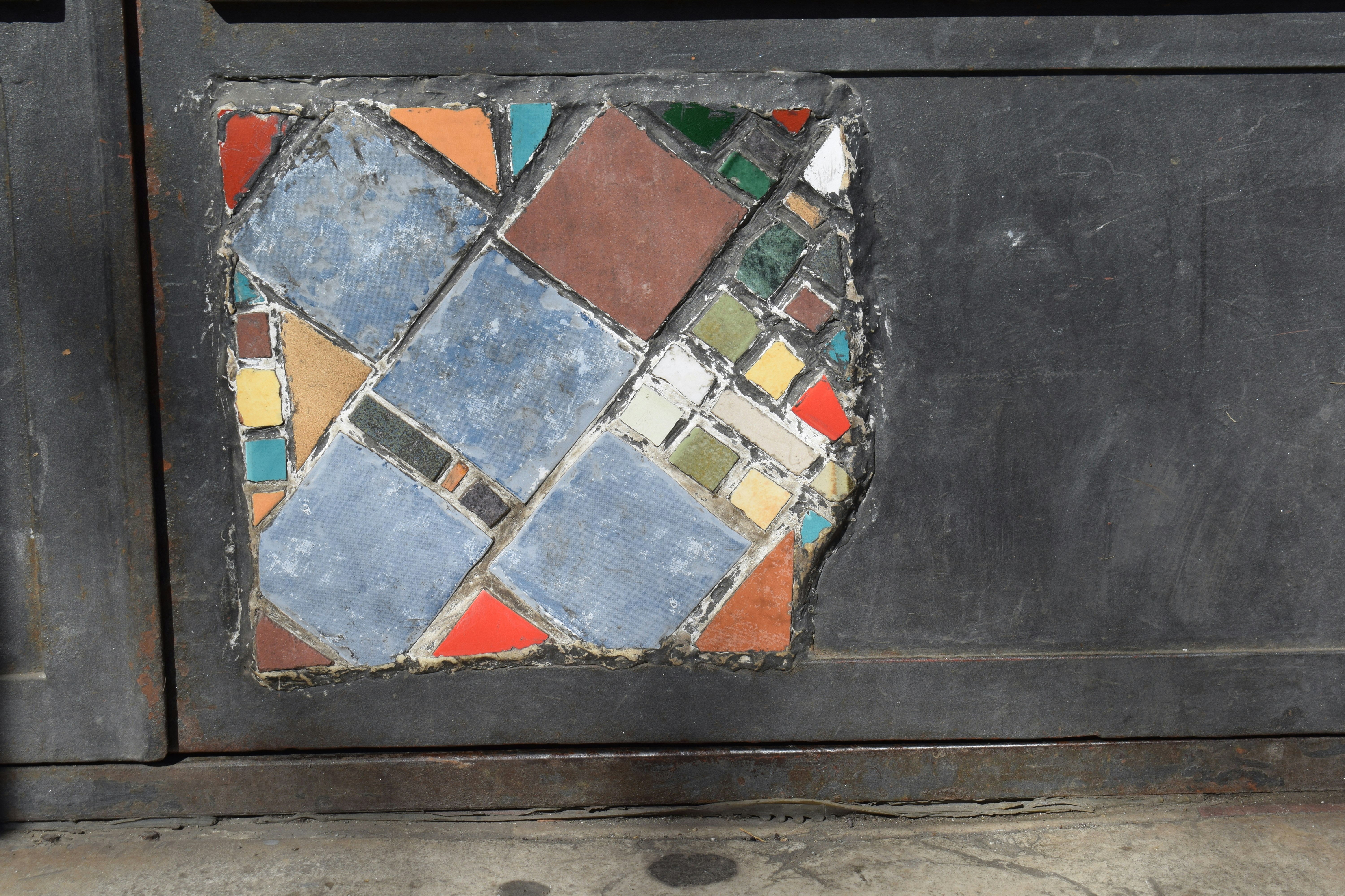 Colorful Tile Inlay on Weathered Door Panel