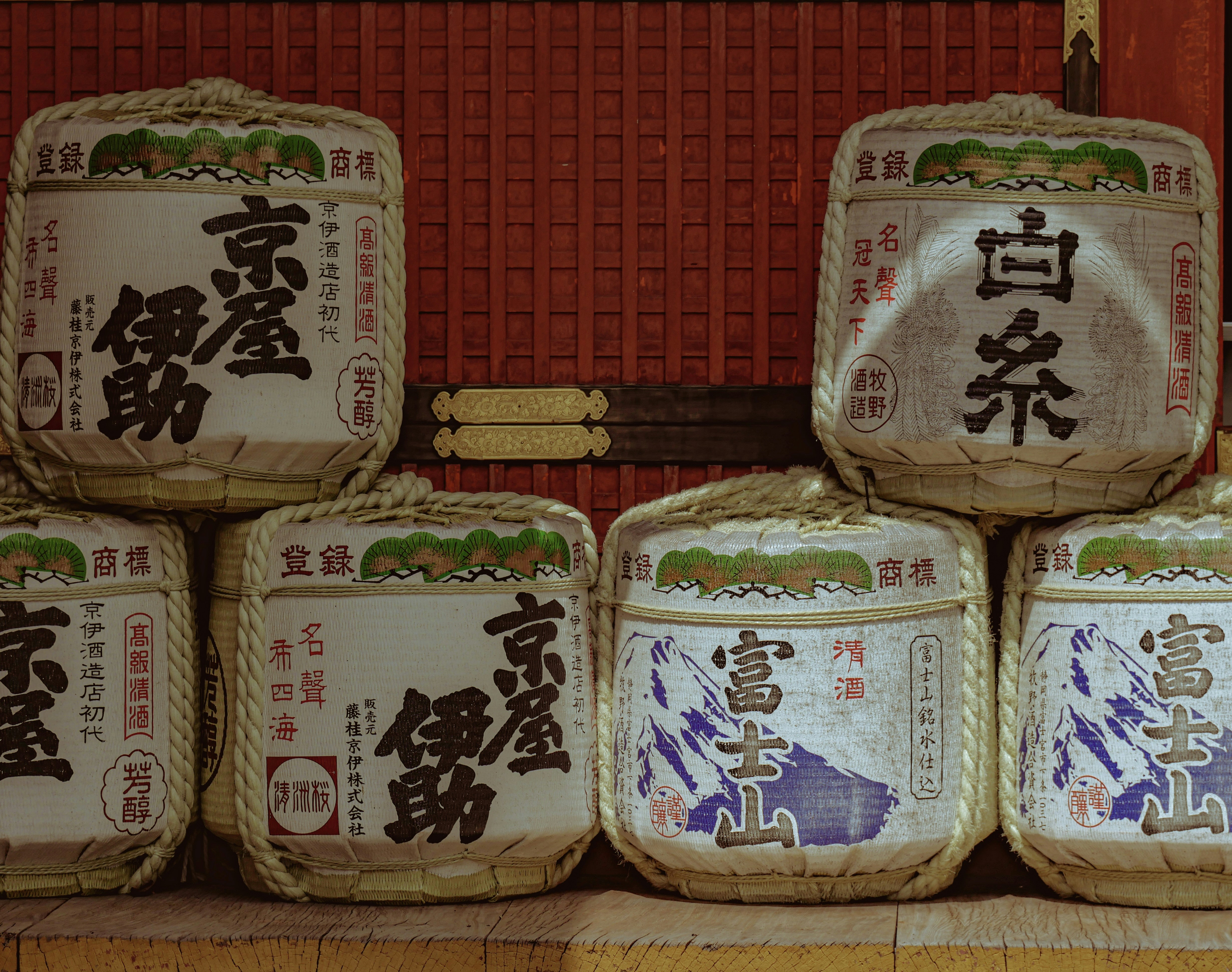 Row of Tied Sake Barrels Under a Red Roof