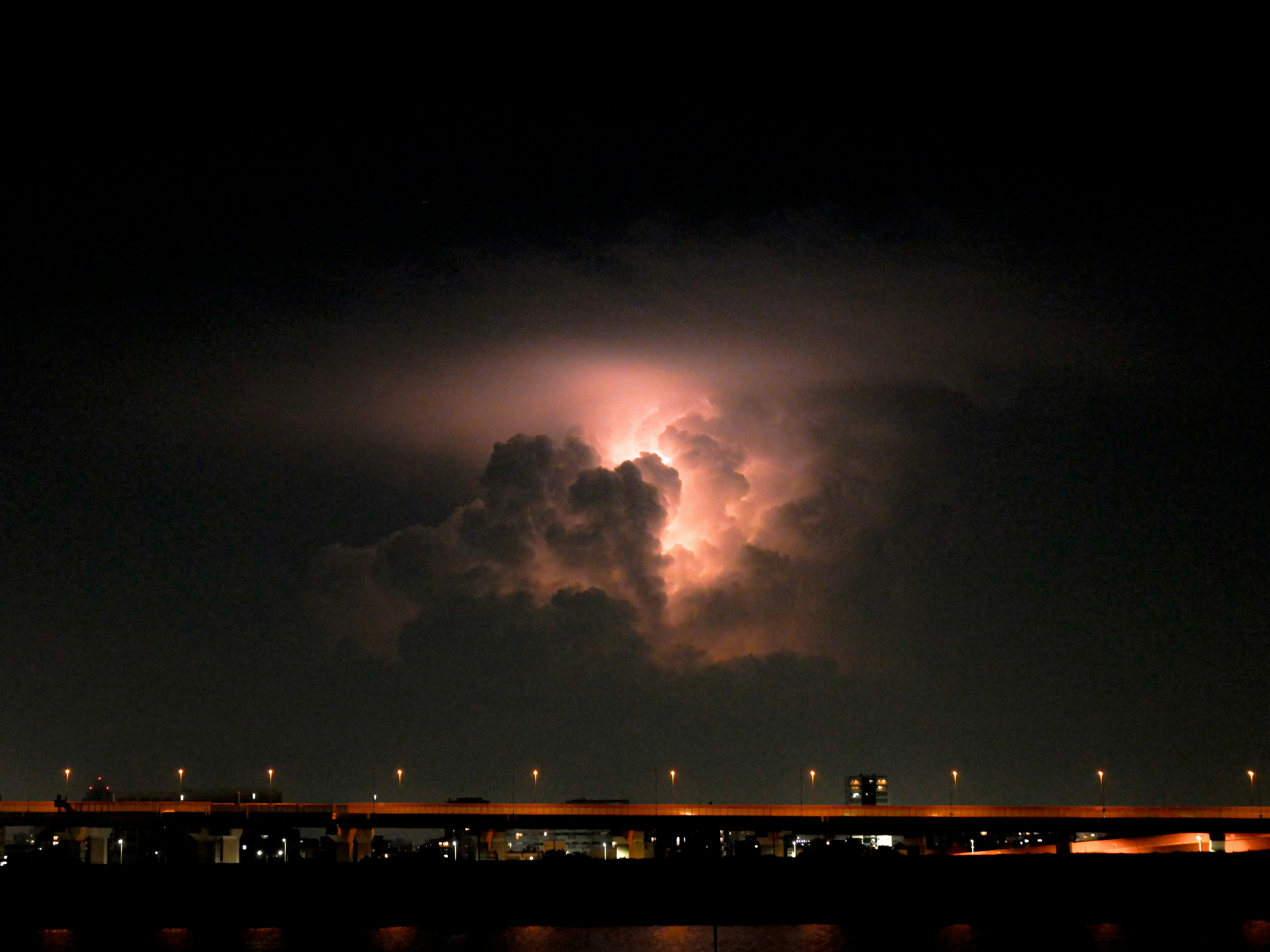 Luminous Cloud Over a Quiet Night Bridge