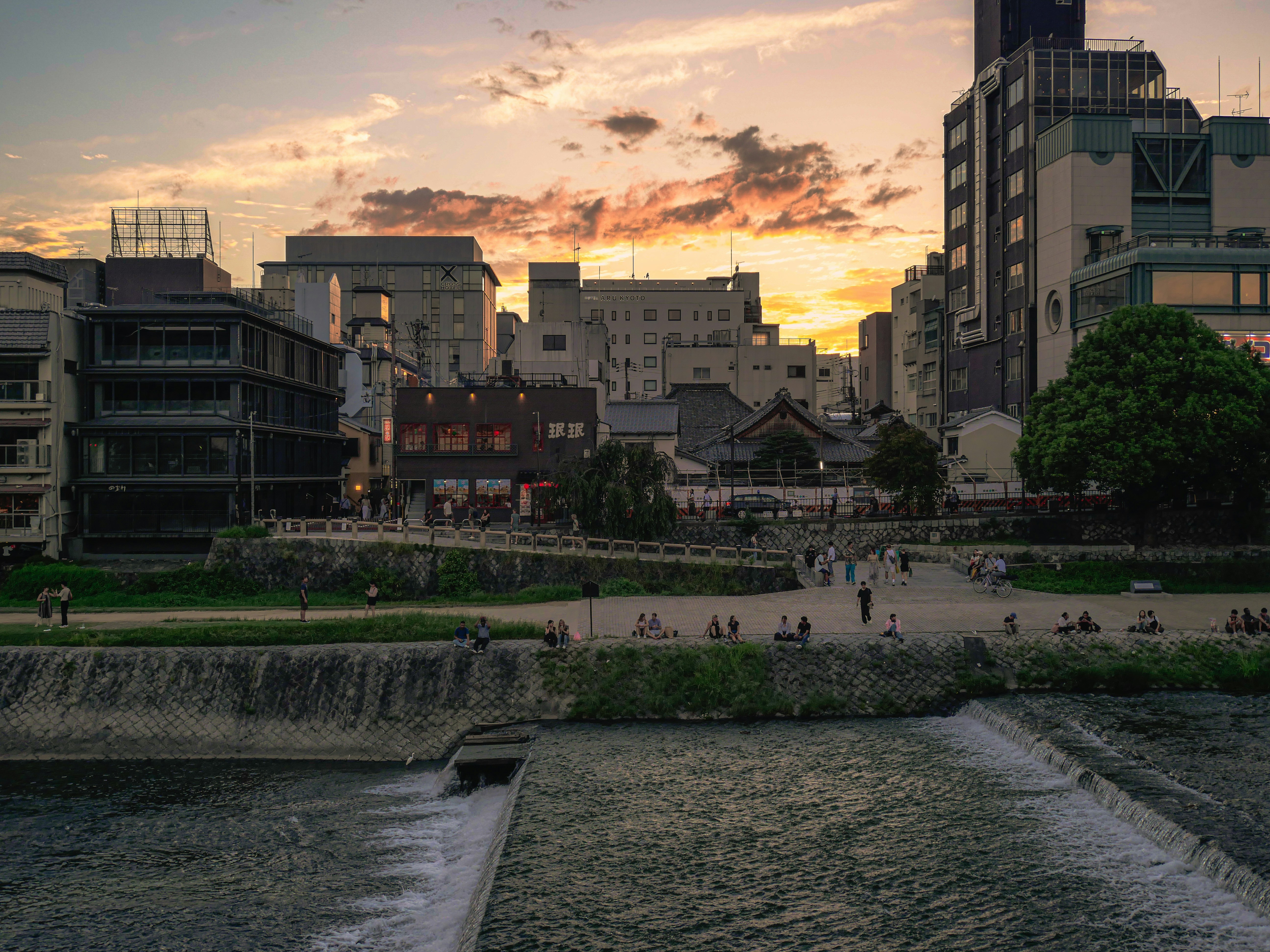 Sunset over the Urban Riverfront: People, Water, and Modern Architecture