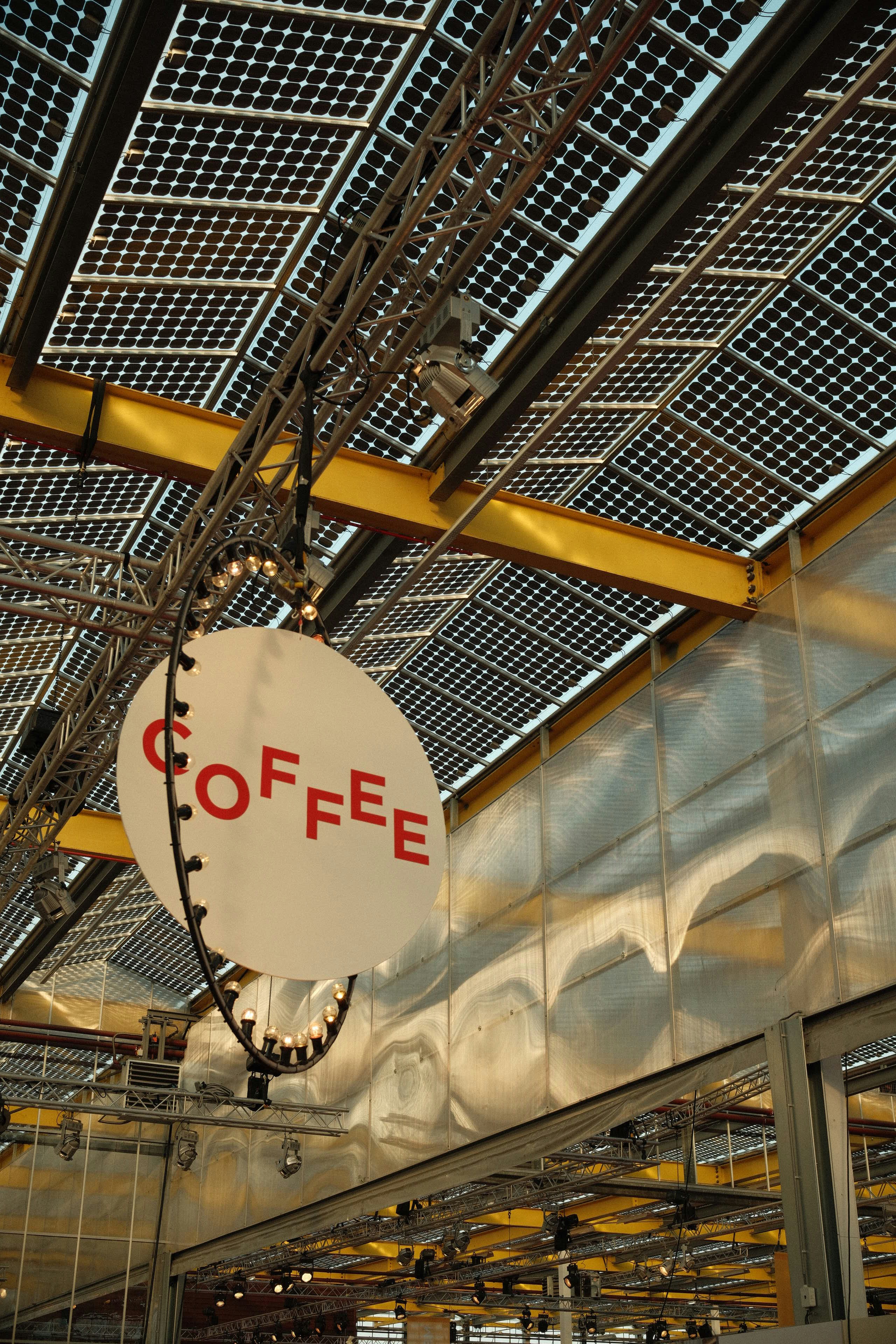 Industrial Coffee Sign: A Circular LED Emblem in a Modern Market Hall