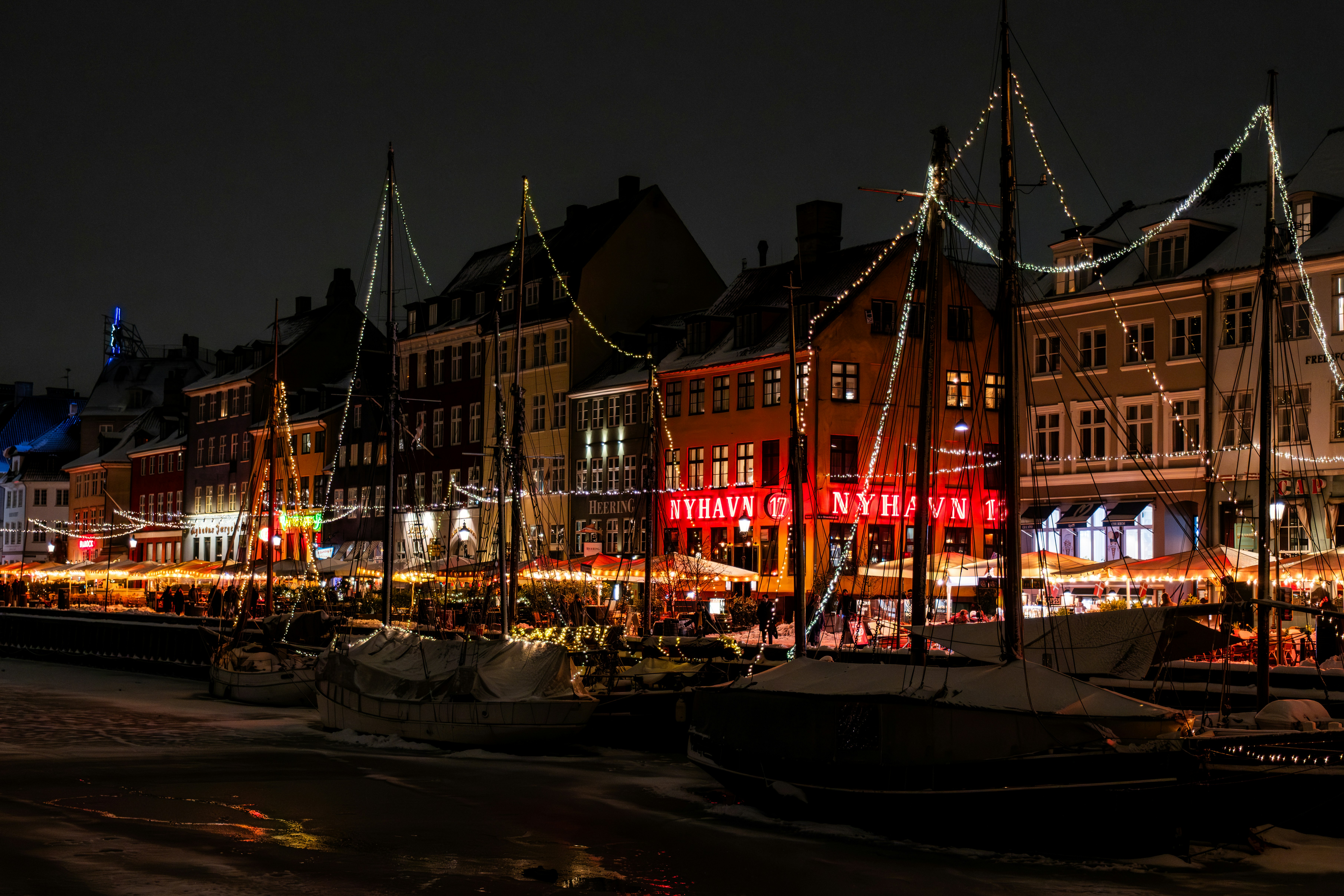 Harbor Lights in Winter Night: Boats, Banners, and Warm Windows