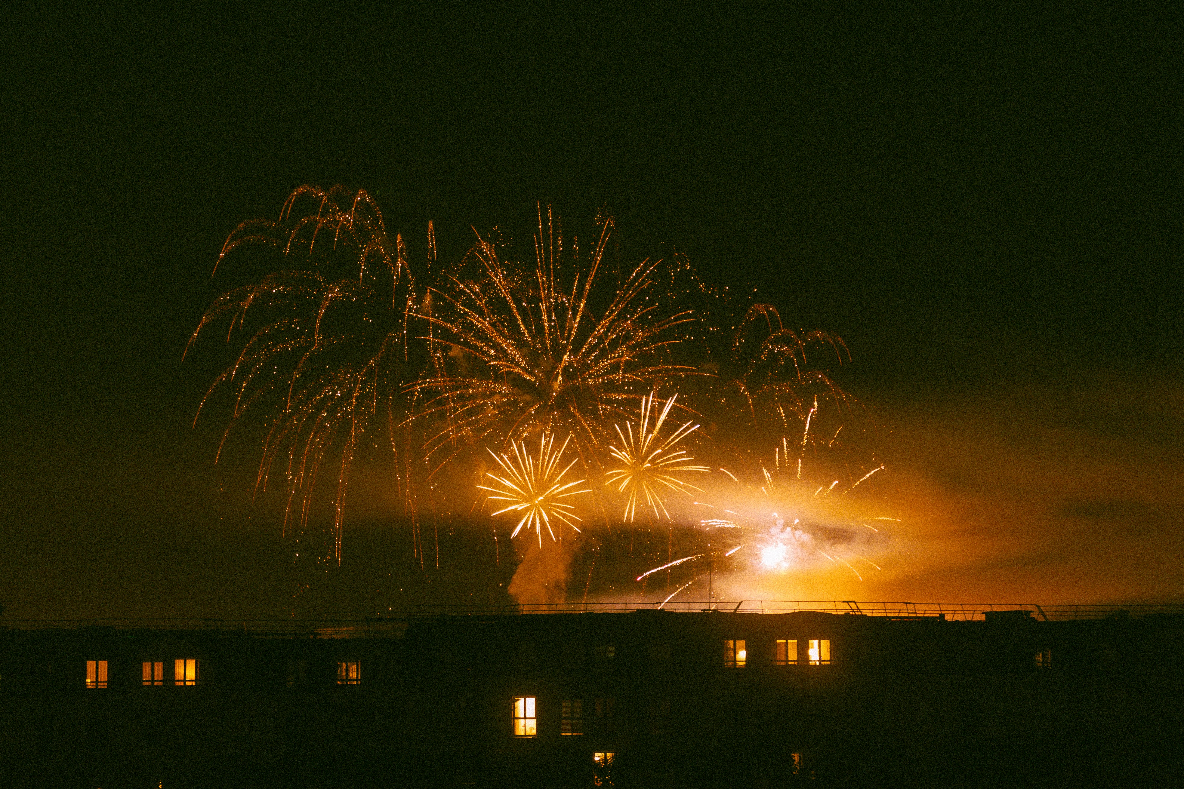 Midnight Fireflowers Over Quiet Rooftops