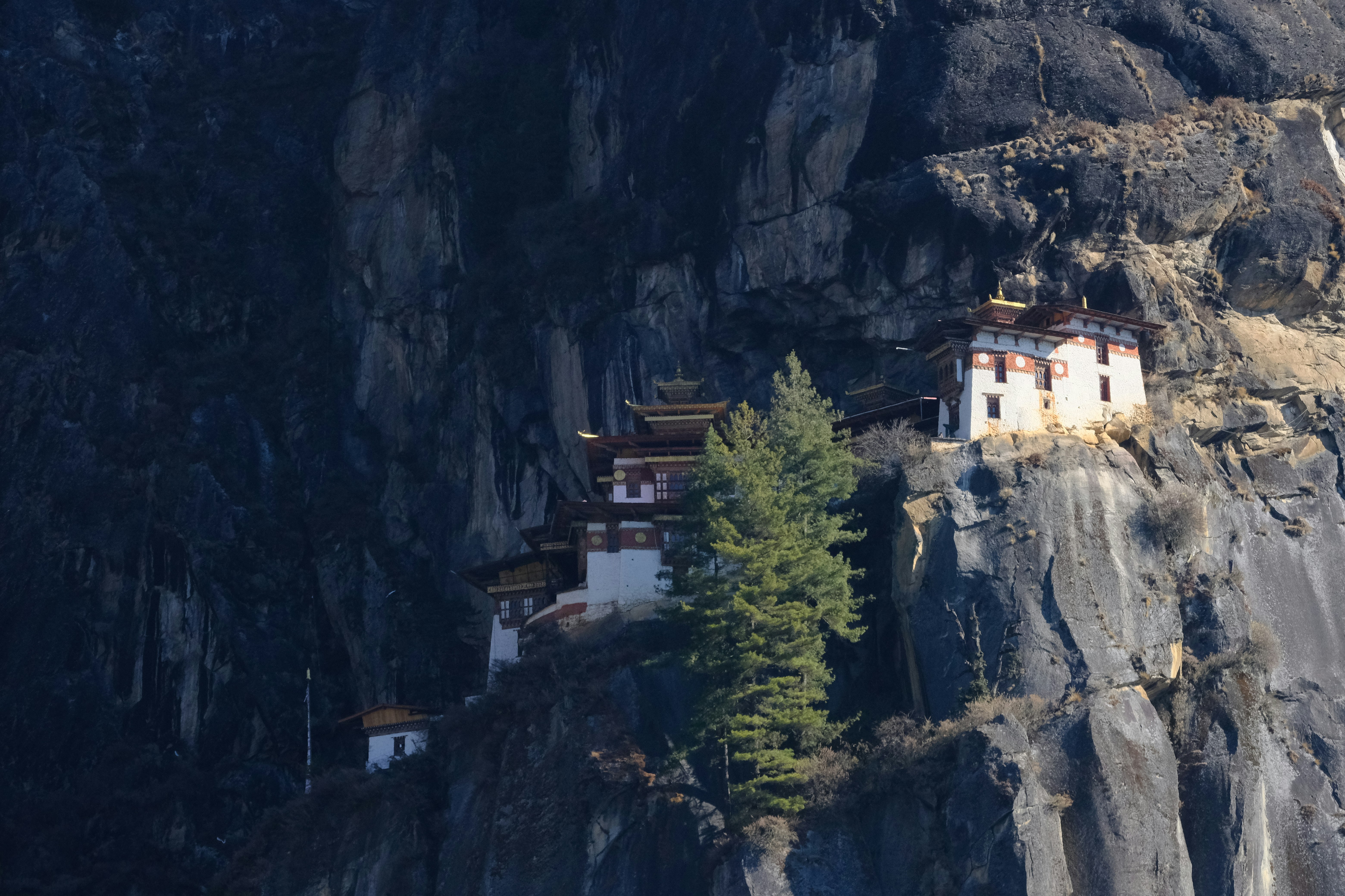 Clifftop Monastery: White-walled Dwellings Amid Dim Granite