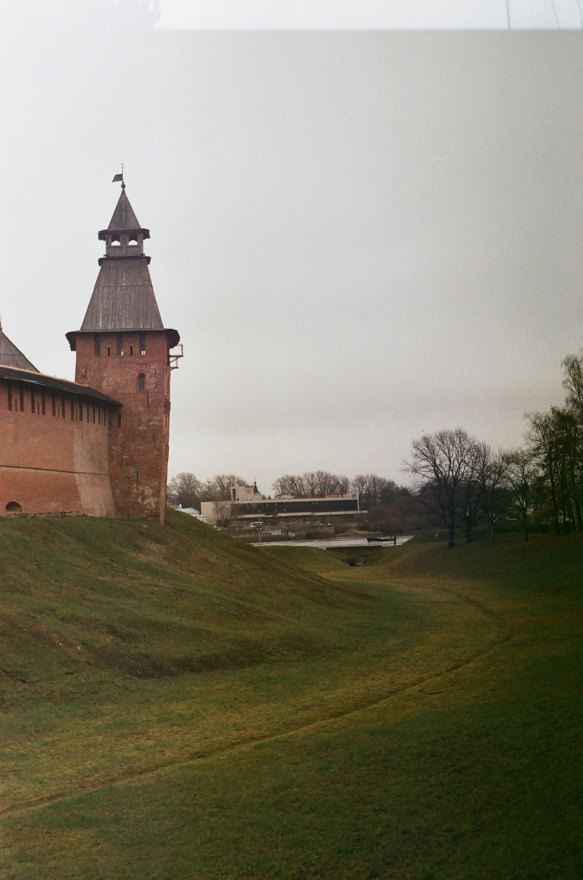 Tower at the Edge: A Sunken Spiral of Green and Brick