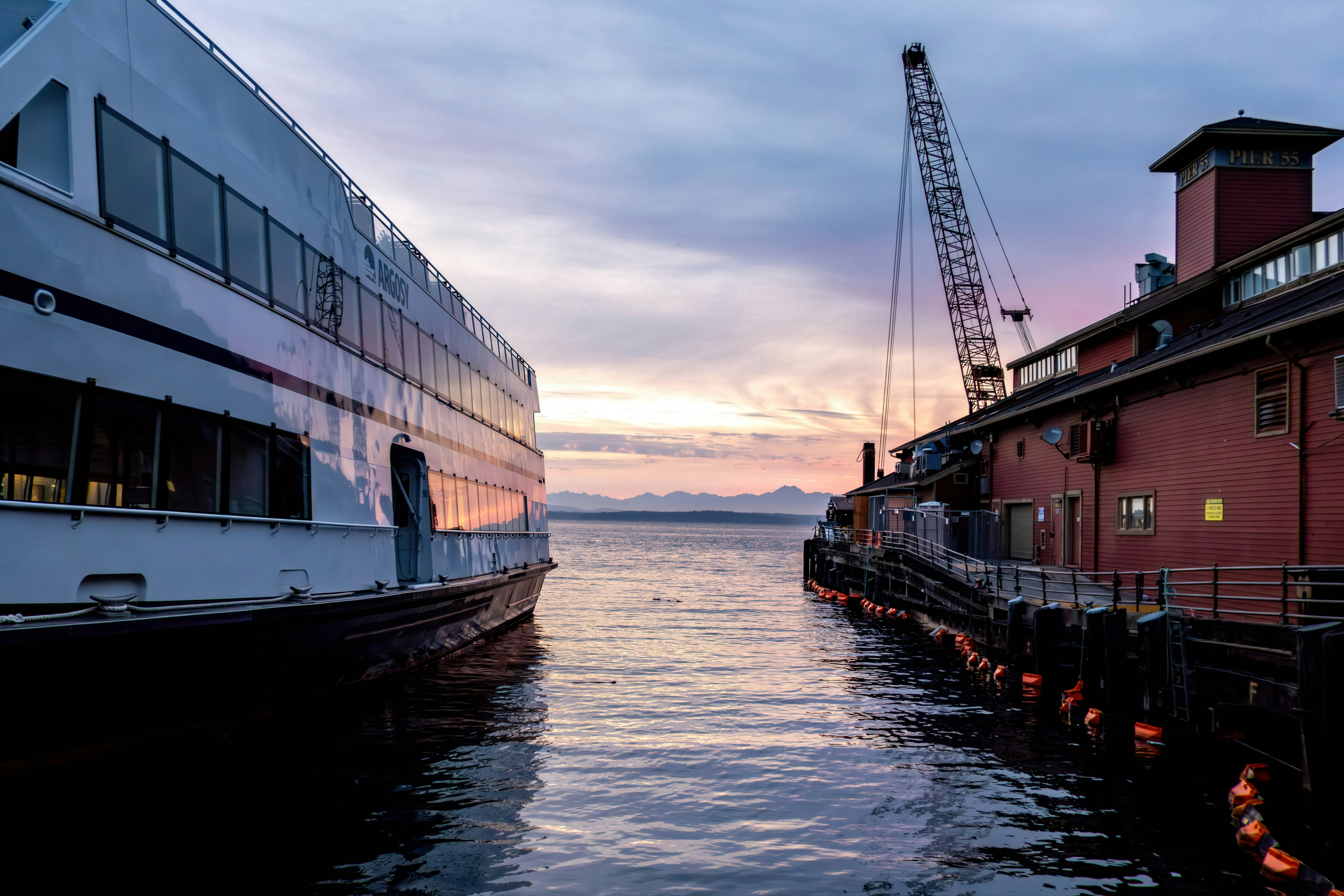 Sunset Standoff Between Docked Vessel and Pierside Crane