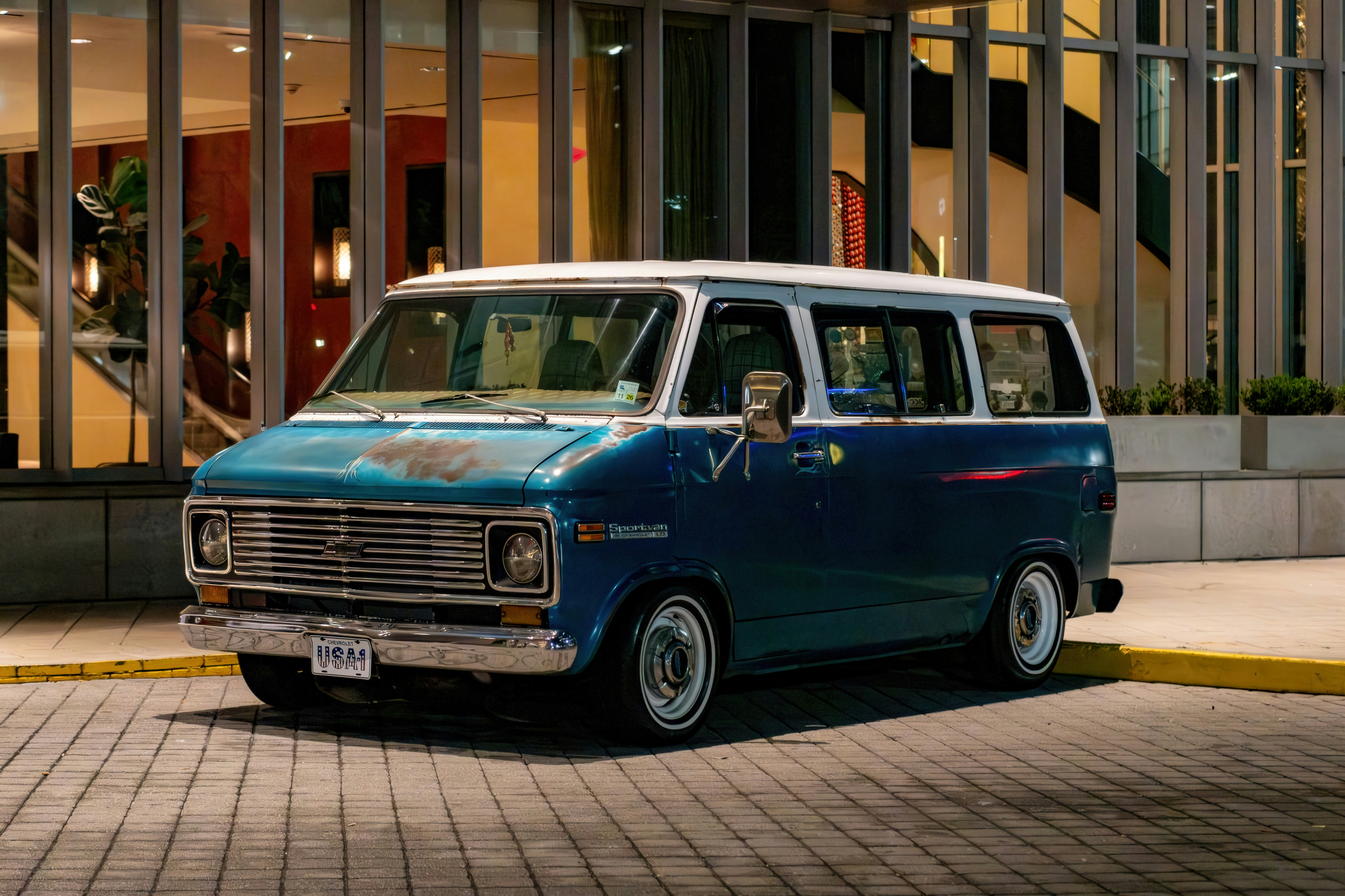 Blue vintage van under urban glow