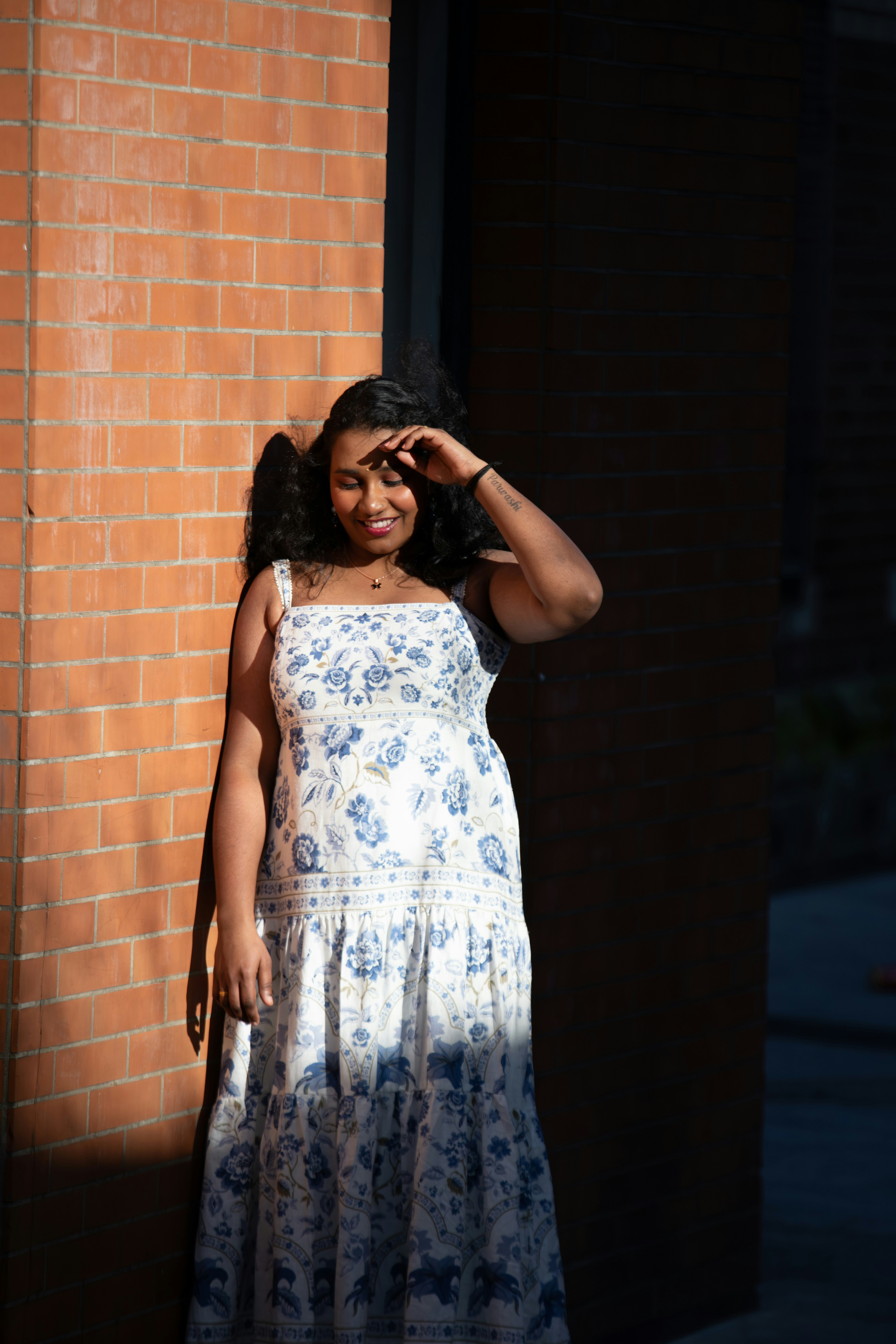 Sunlit Portrait in the Alley: A Southern Breeze Against Brick