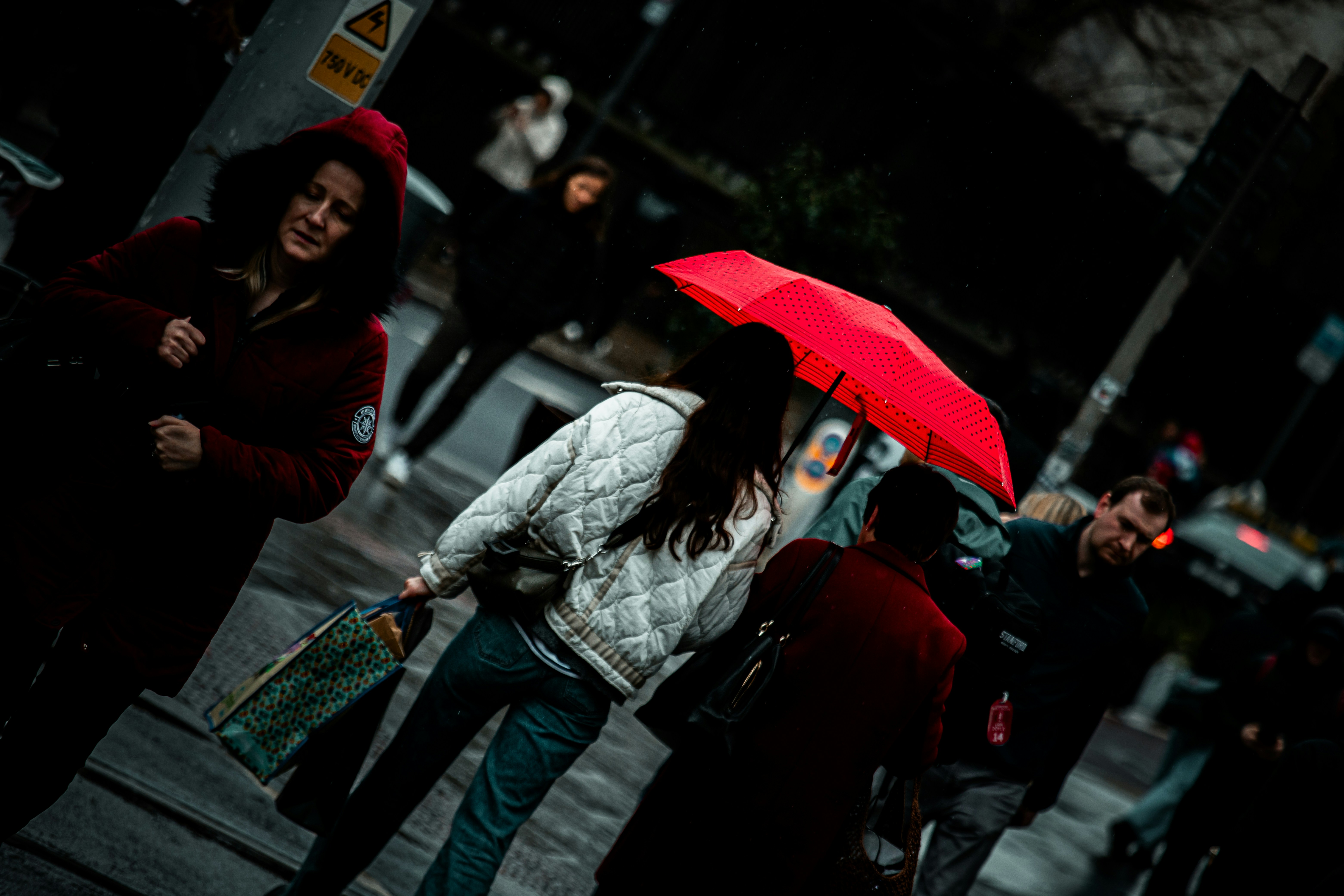 Red Umbrella Amid Quiet Rain on the City Walk